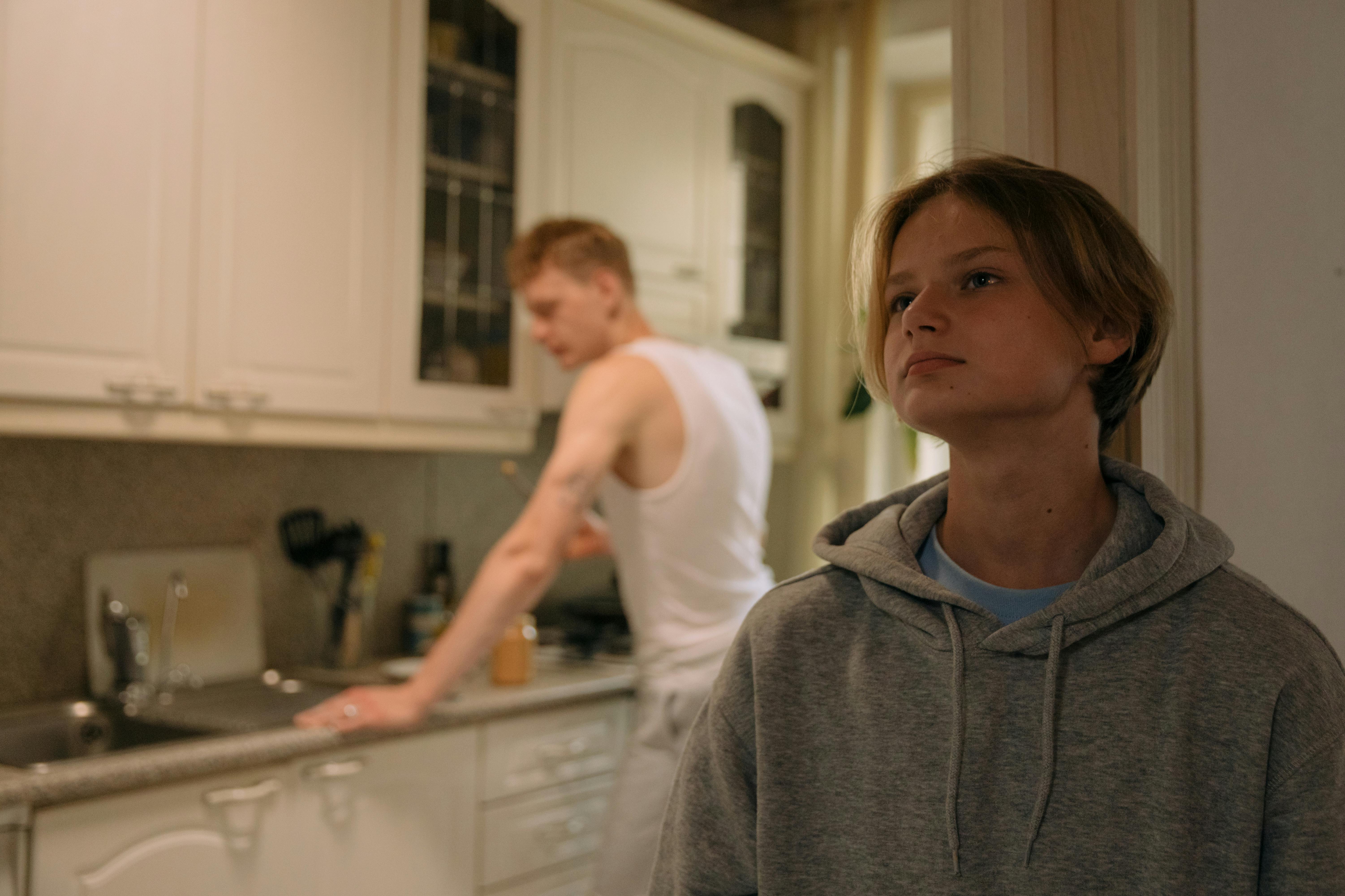 Man Entering Kitchen with Box · Free Stock Photo