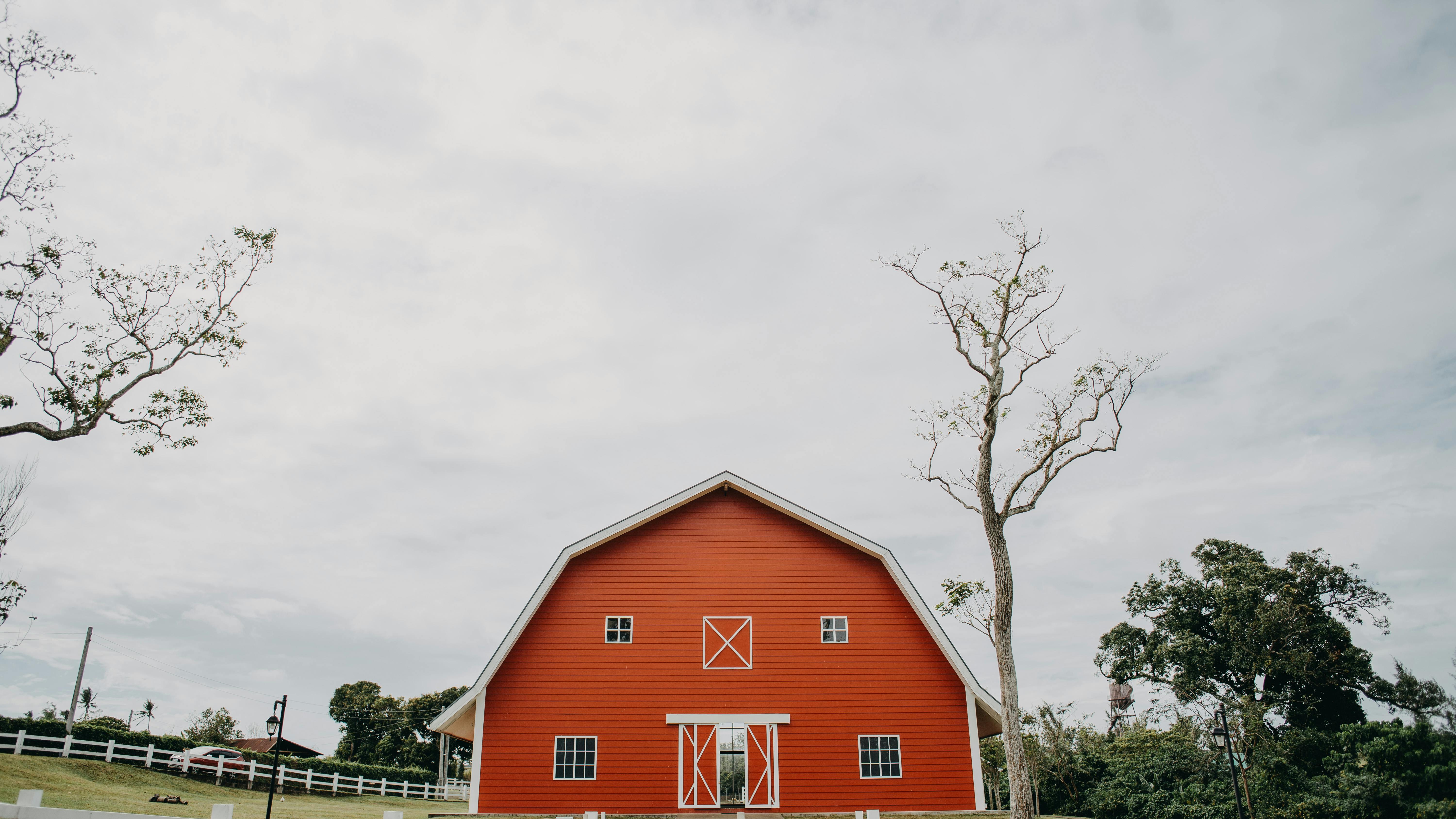 An Orange Barn House Under White Clouds · Free Stock Photo