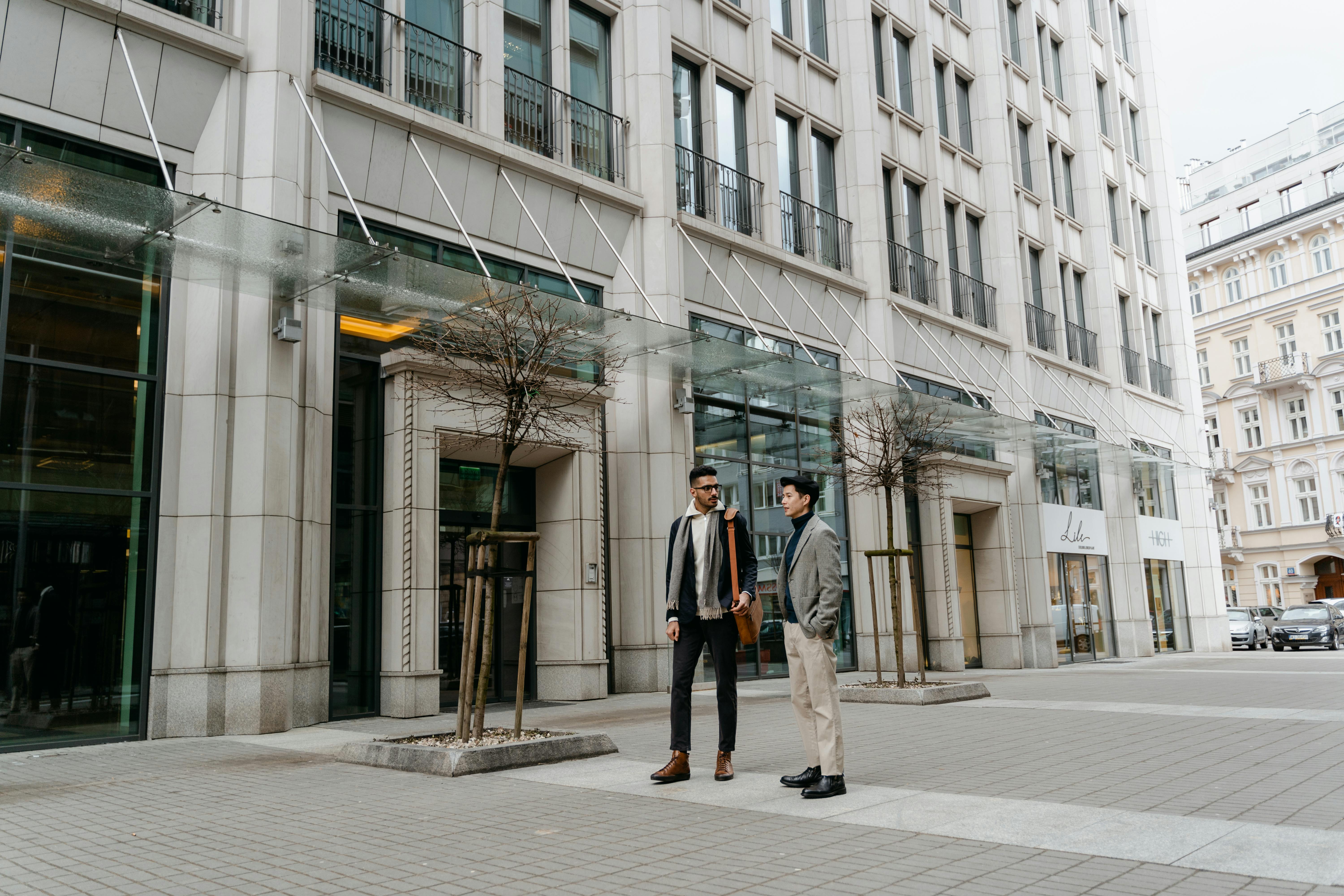 Men Talking In Front of a Building · Free Stock Photo