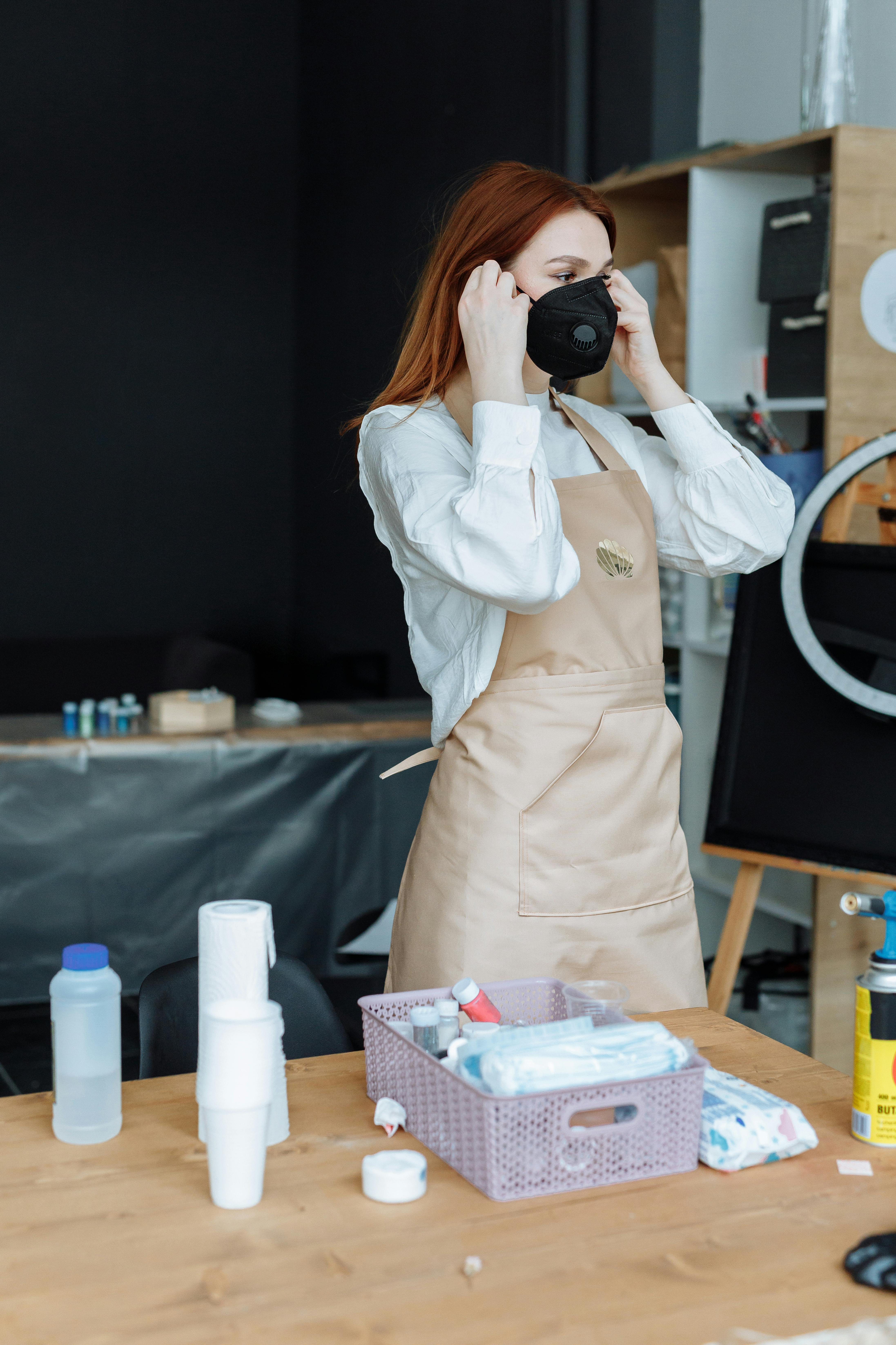 Woman Wearing Black Face Mask and Brown Apron · Free Stock Photo