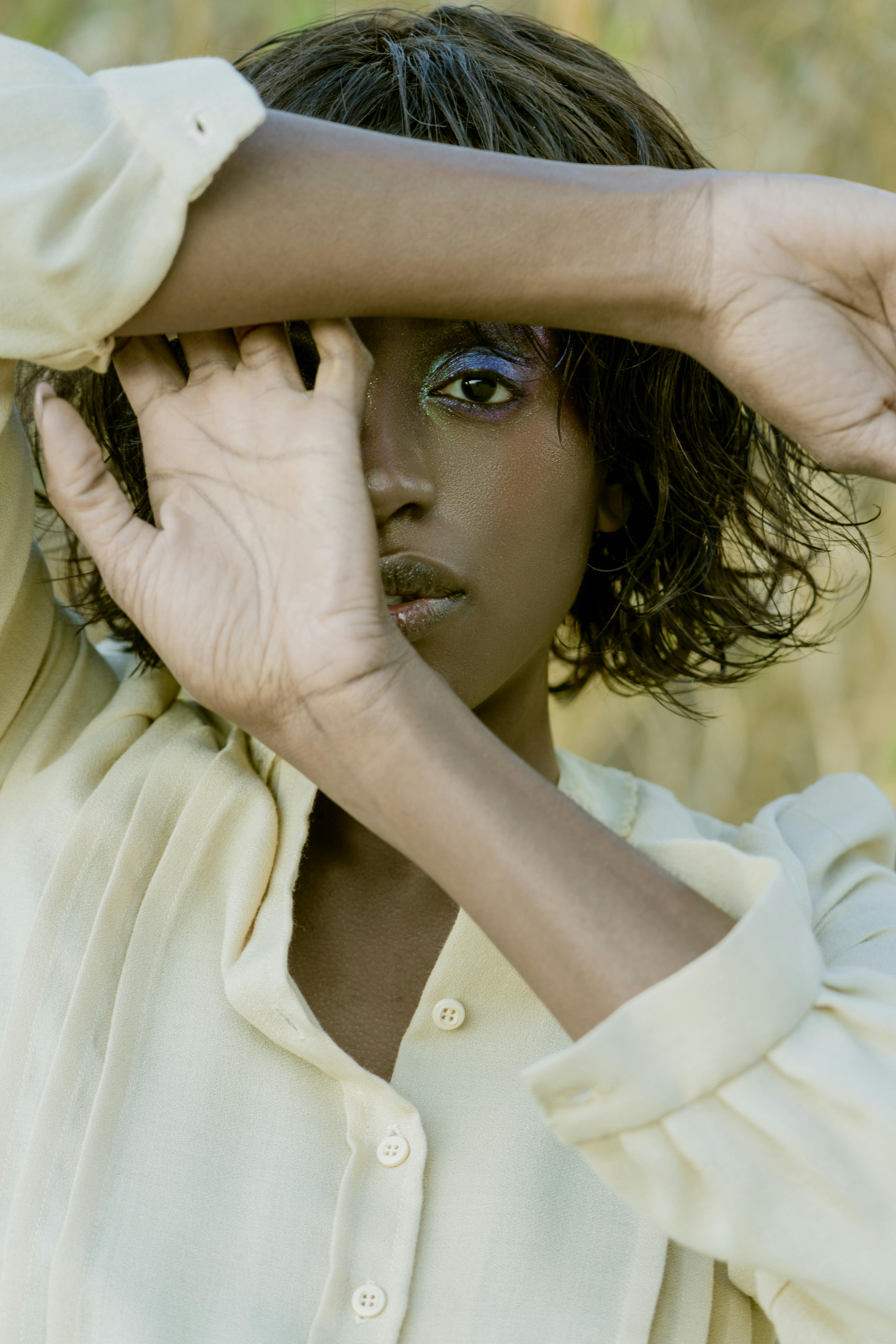 A Woman Covering Half of Her Face with Her Hands · Free Stock Photo