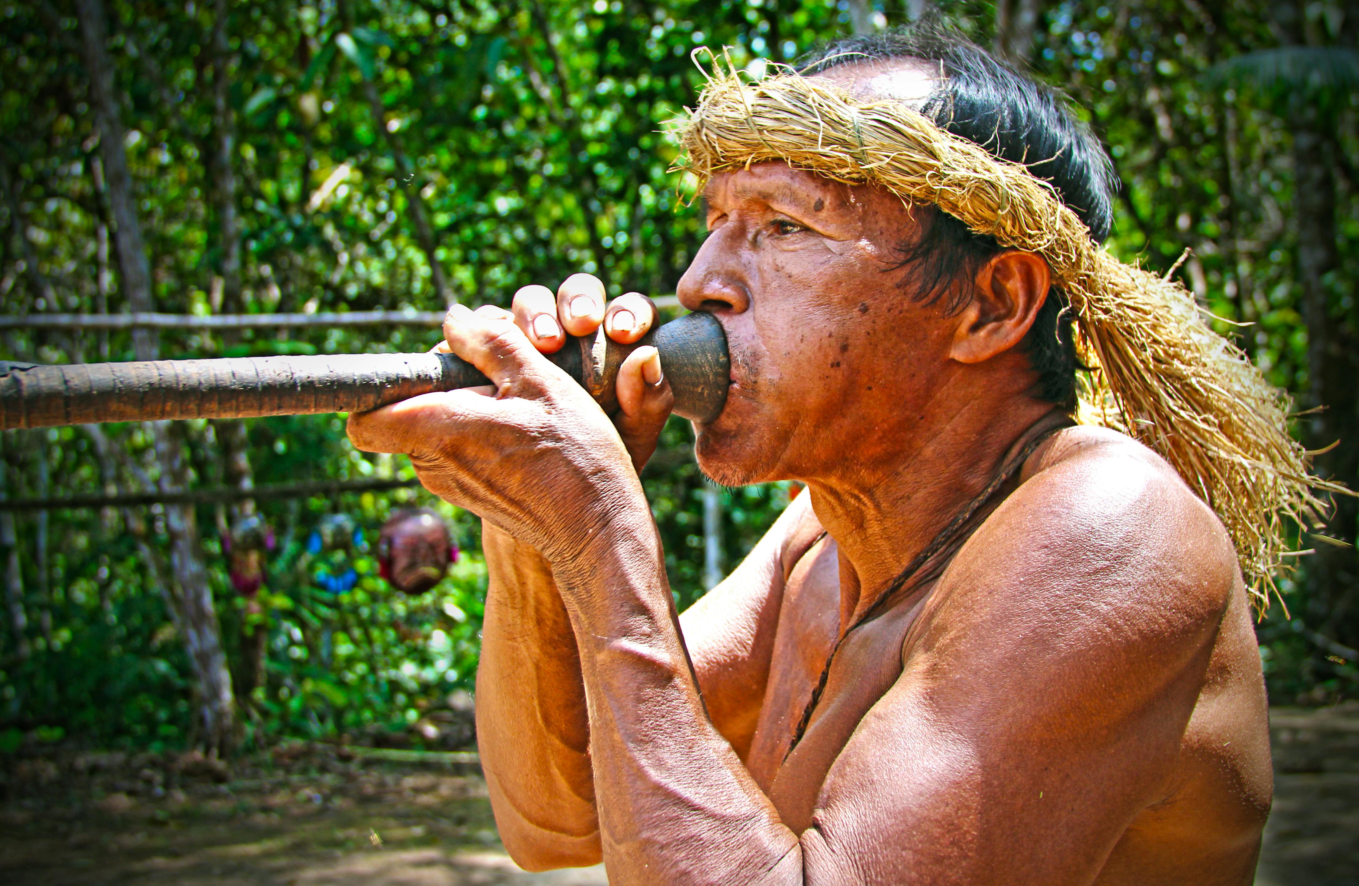 Man from a Tribe Using a Blowgun · Free Stock Photo