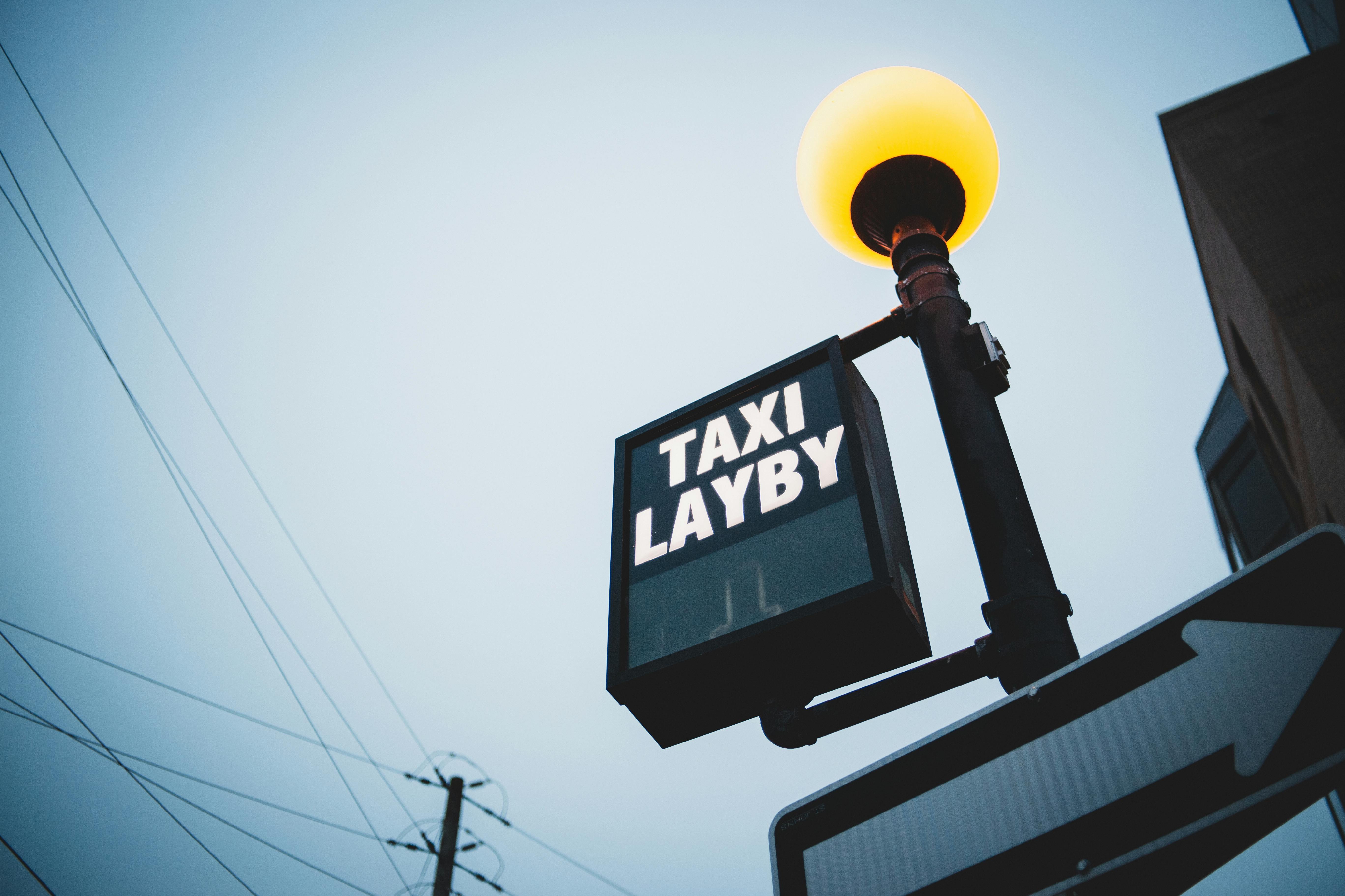 Yellow luminous streetlamp with signboard saying taxi layby · Free ...