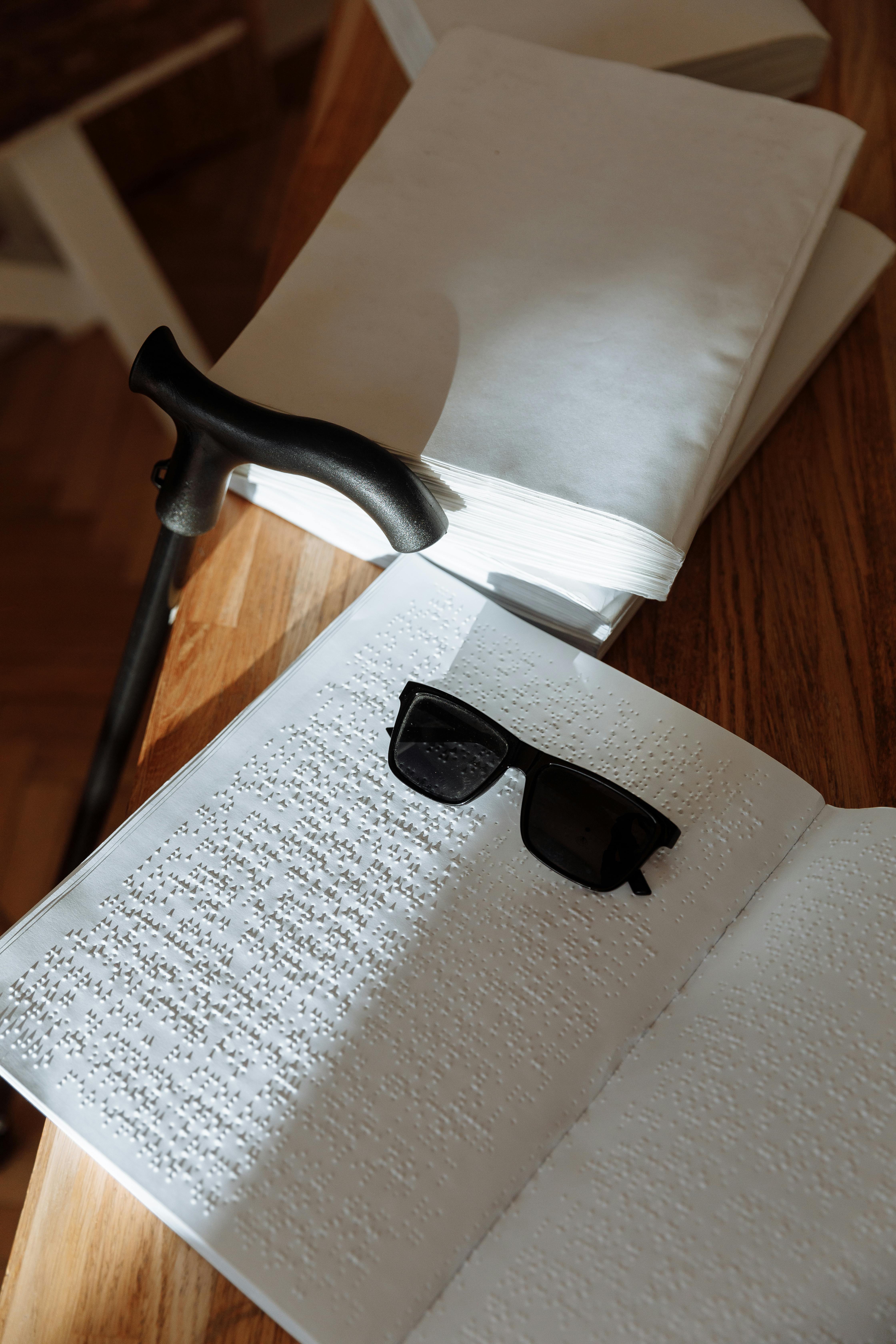 Black Sunglasses on Book Pages · Free Stock Photo