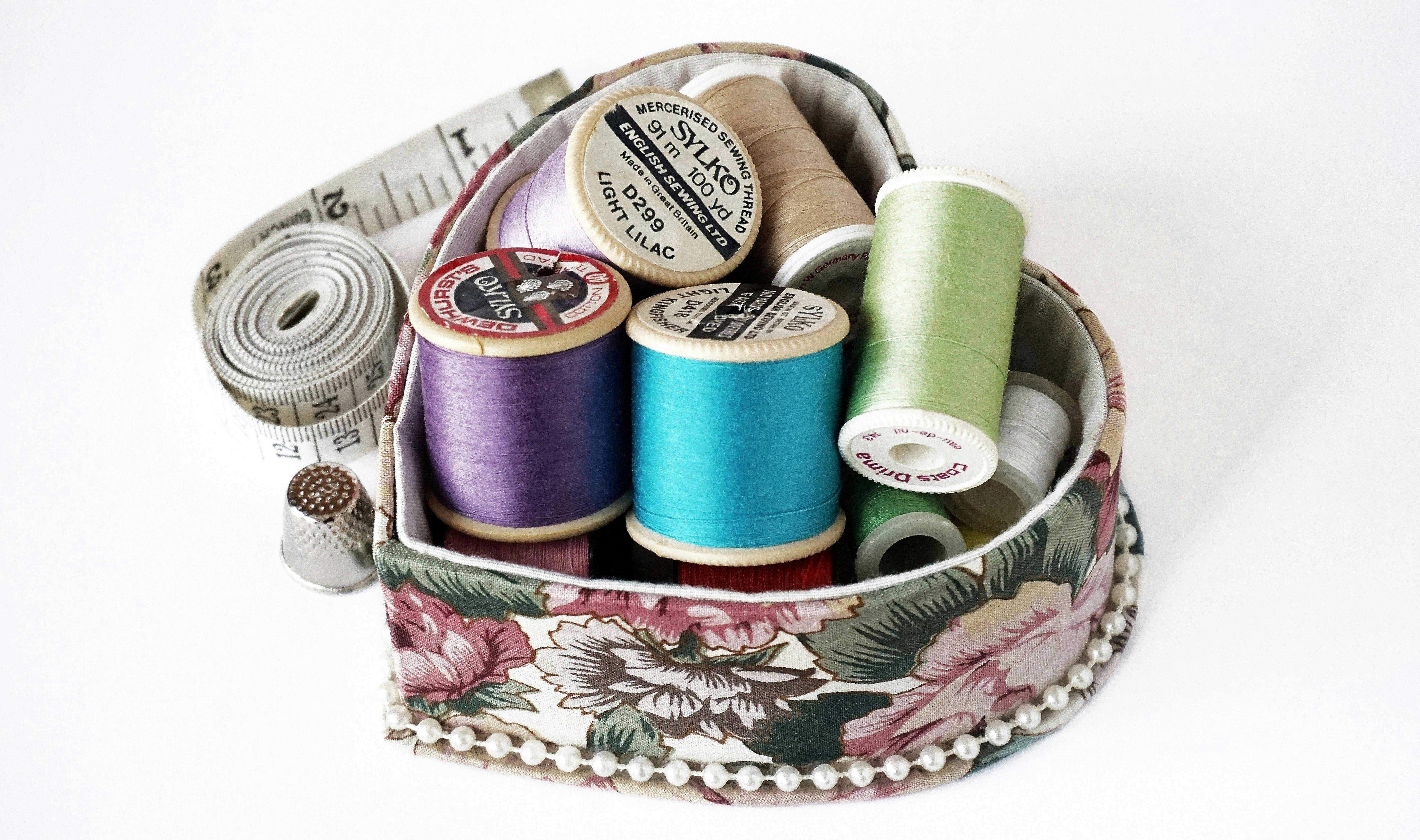 Sewing Threads on a White Surface · Free Stock Photo