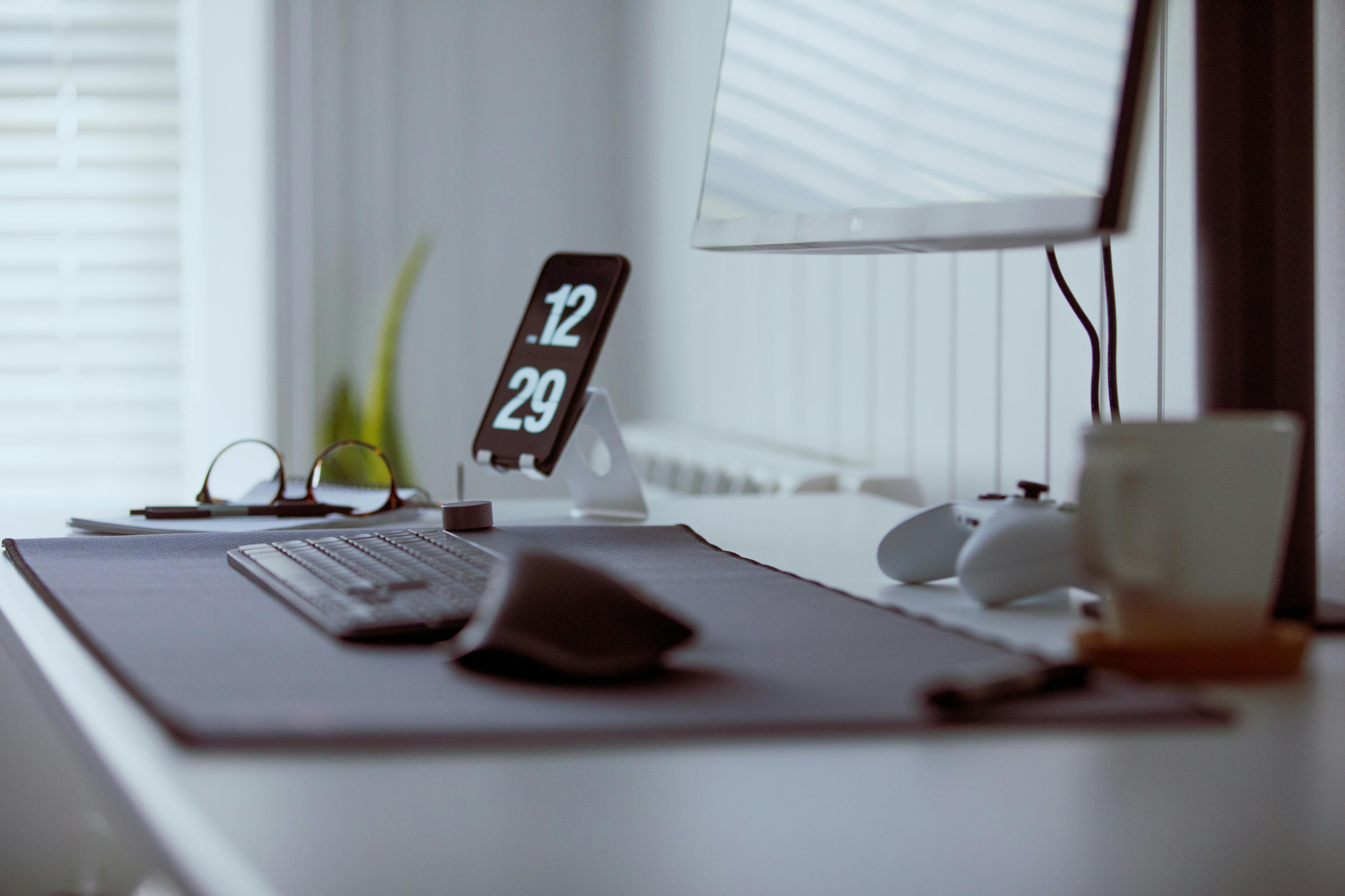 Cellphone and Computer Keyboard on Top of a Desk · Free Stock Photo