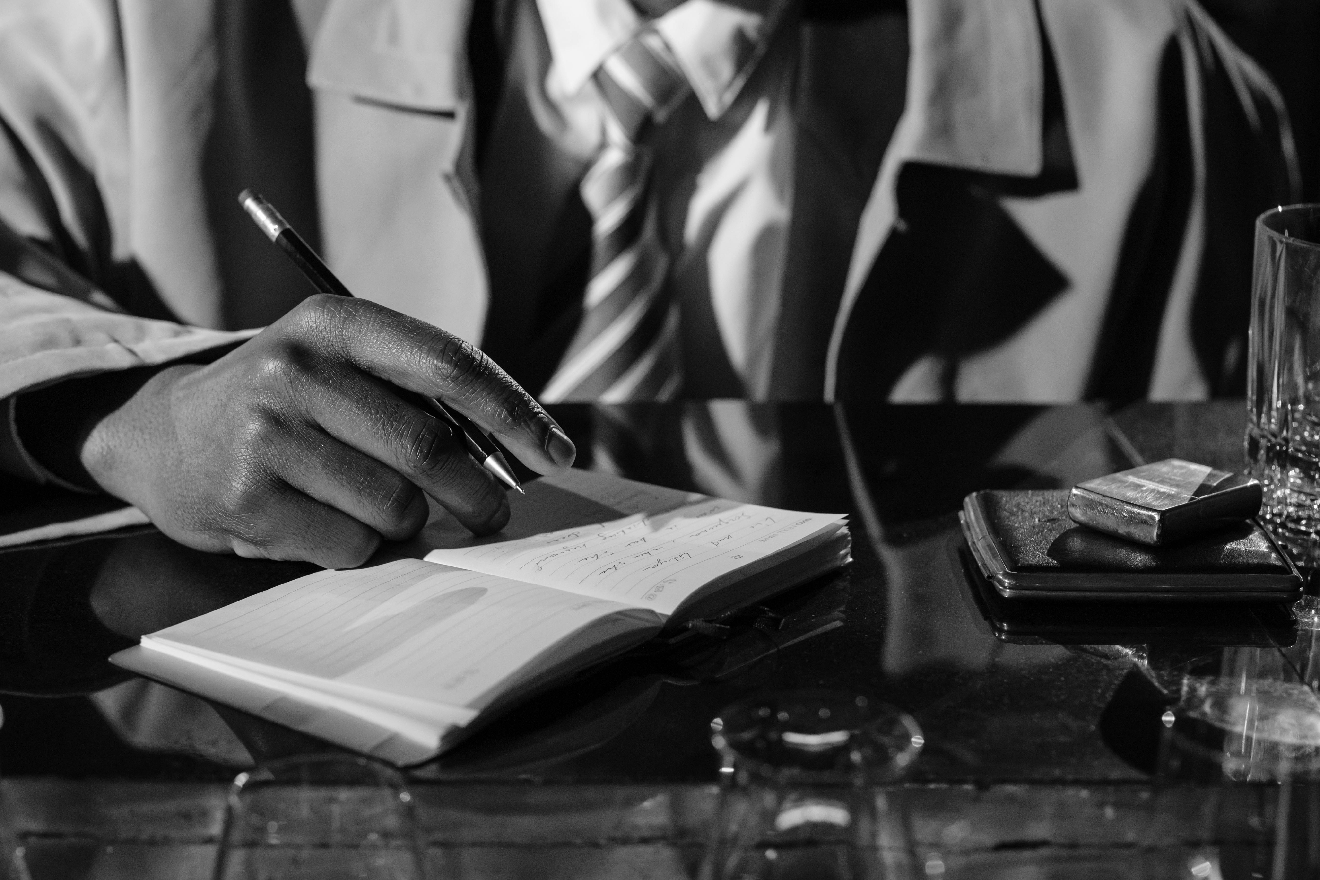 Monochrome Photo of Person Taking Down Notes · Free Stock Photo