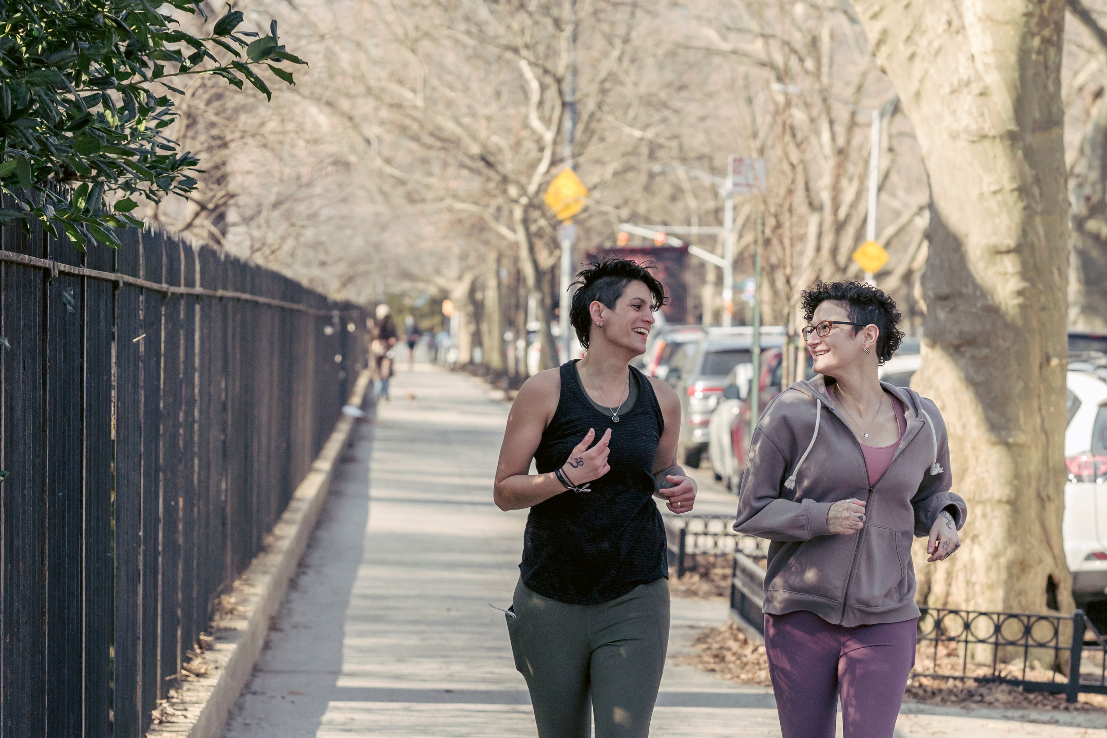Happy women running on sidewalk · Free Stock Photo