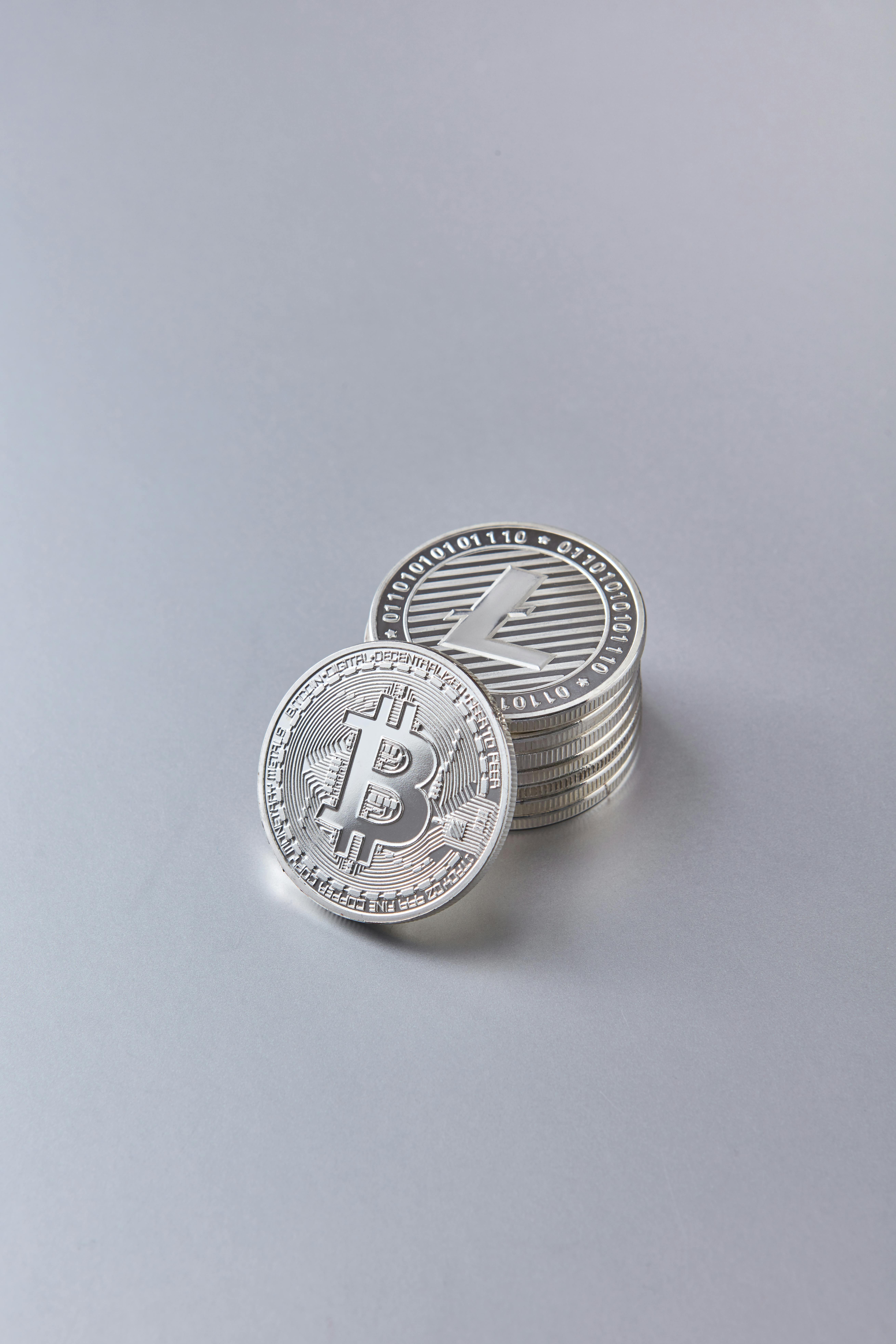Stacked Up Coins on White Surface · Free Stock Photo