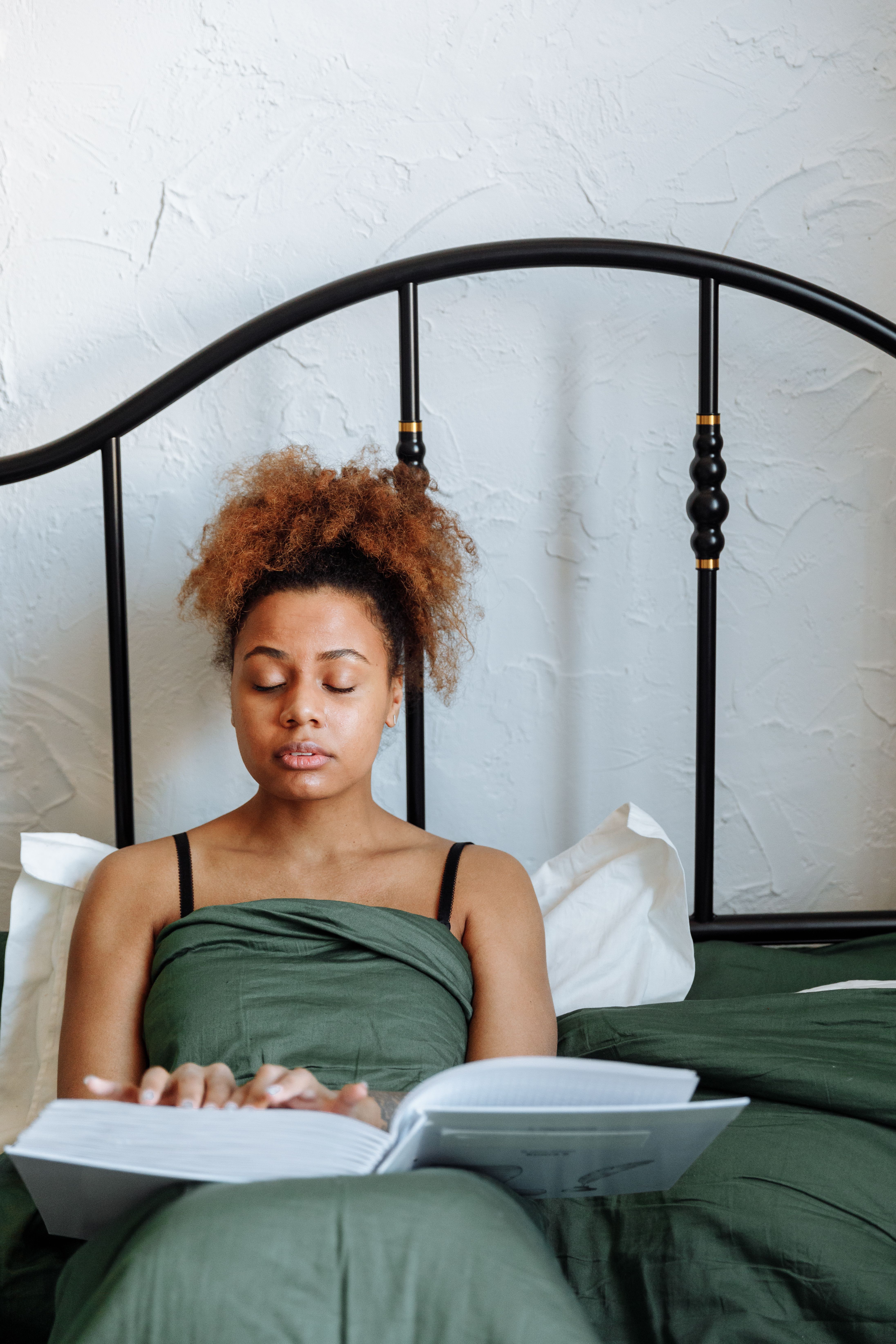 A Woman Using a Braille Book While on the Bed · Free Stock Photo