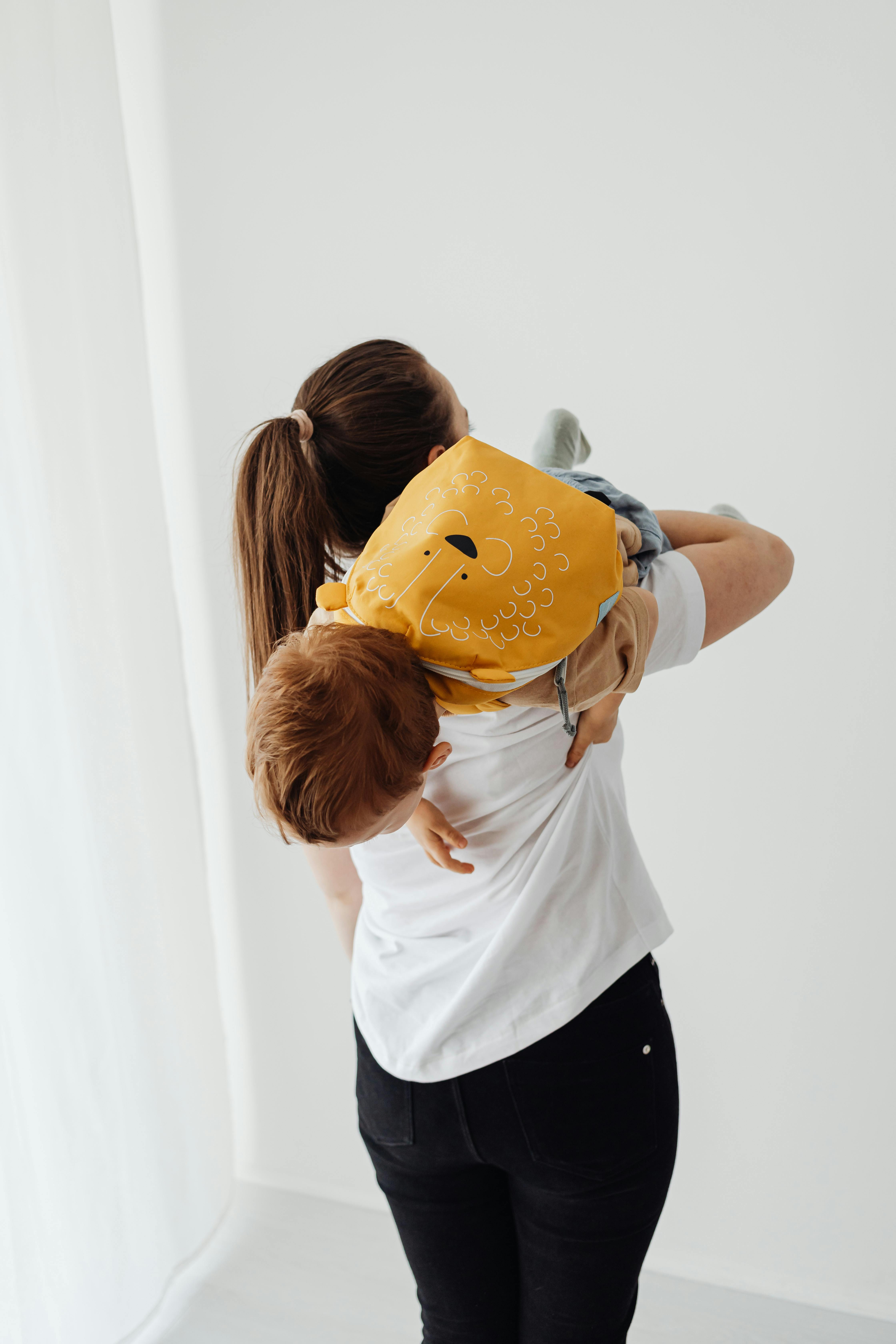 Woman Carrying Cute Child on Back · Free Stock Photo