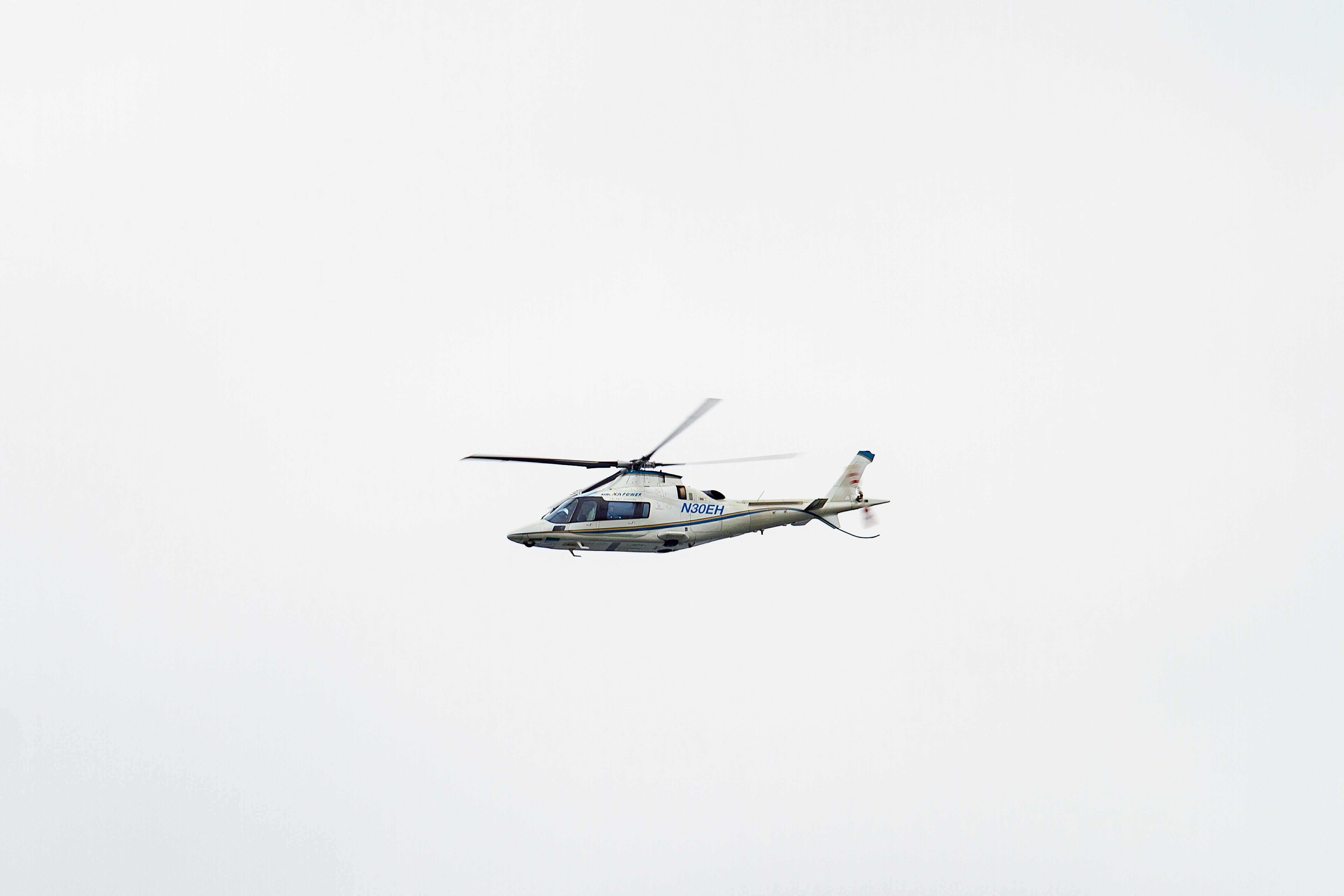 Selective Photograph of White Helicopter Near Brown Mountains · Free ...