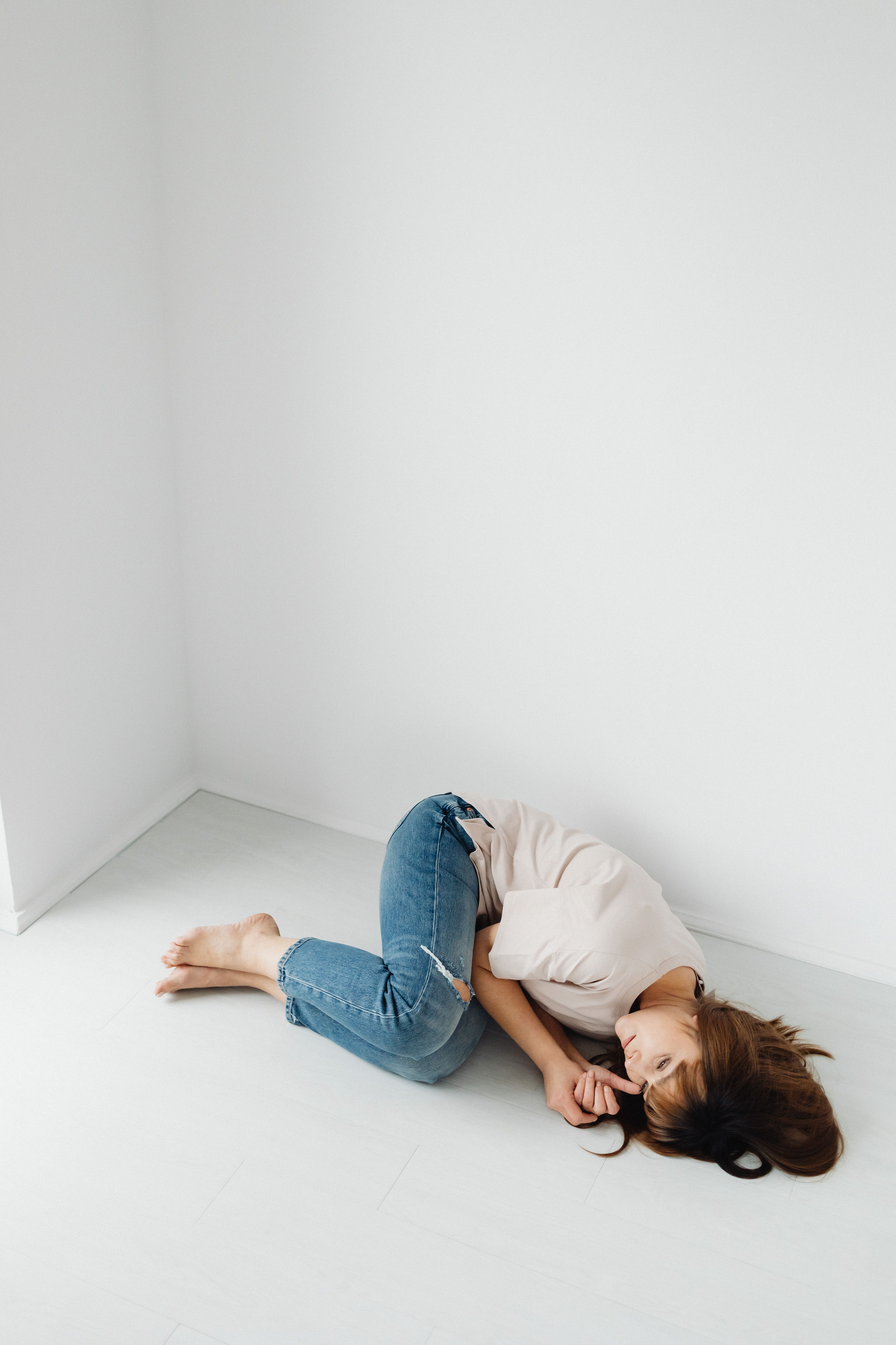 Woman Curled Up on Floor · Free Stock Photo