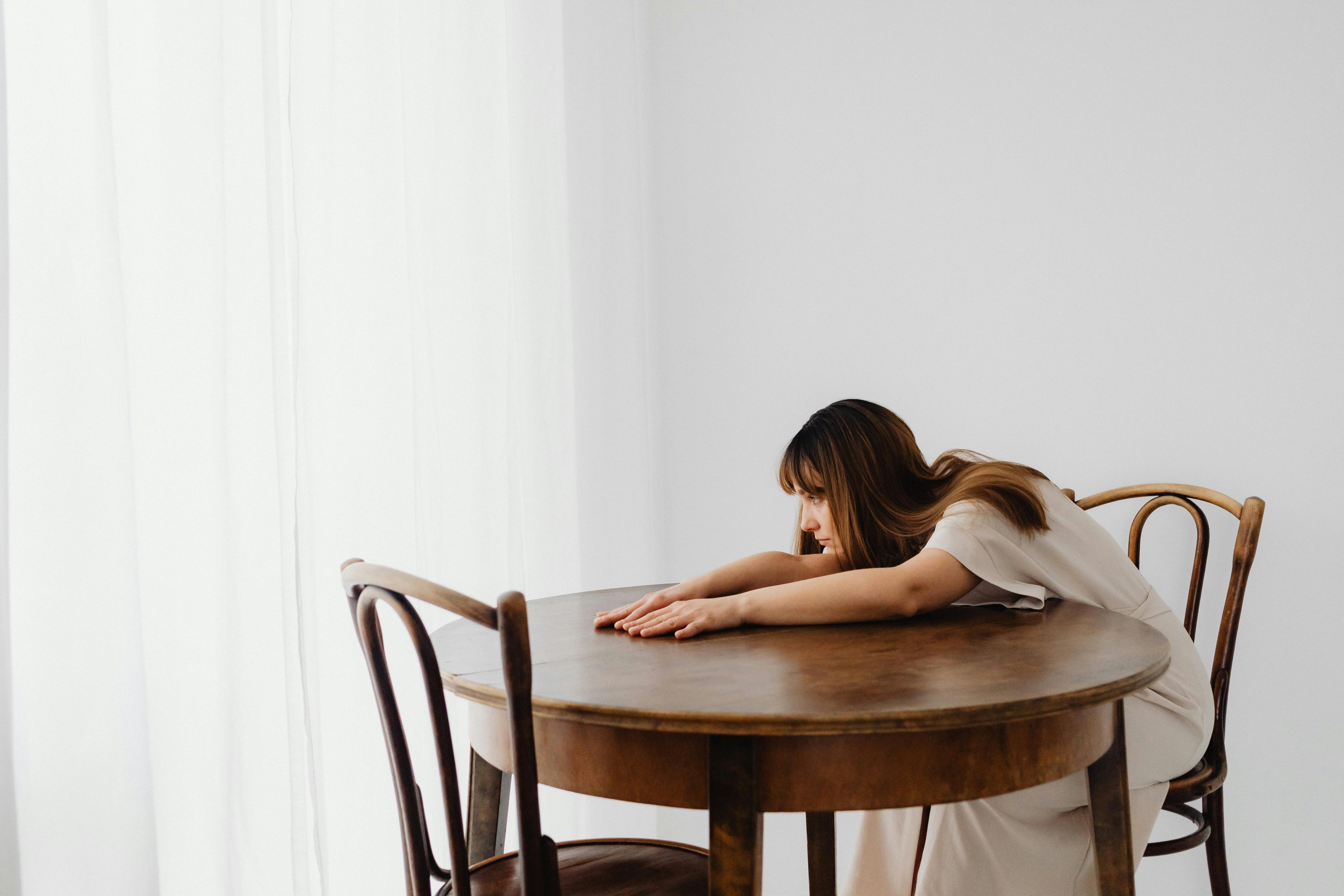 Woman Leaning on Table · Free Stock Photo