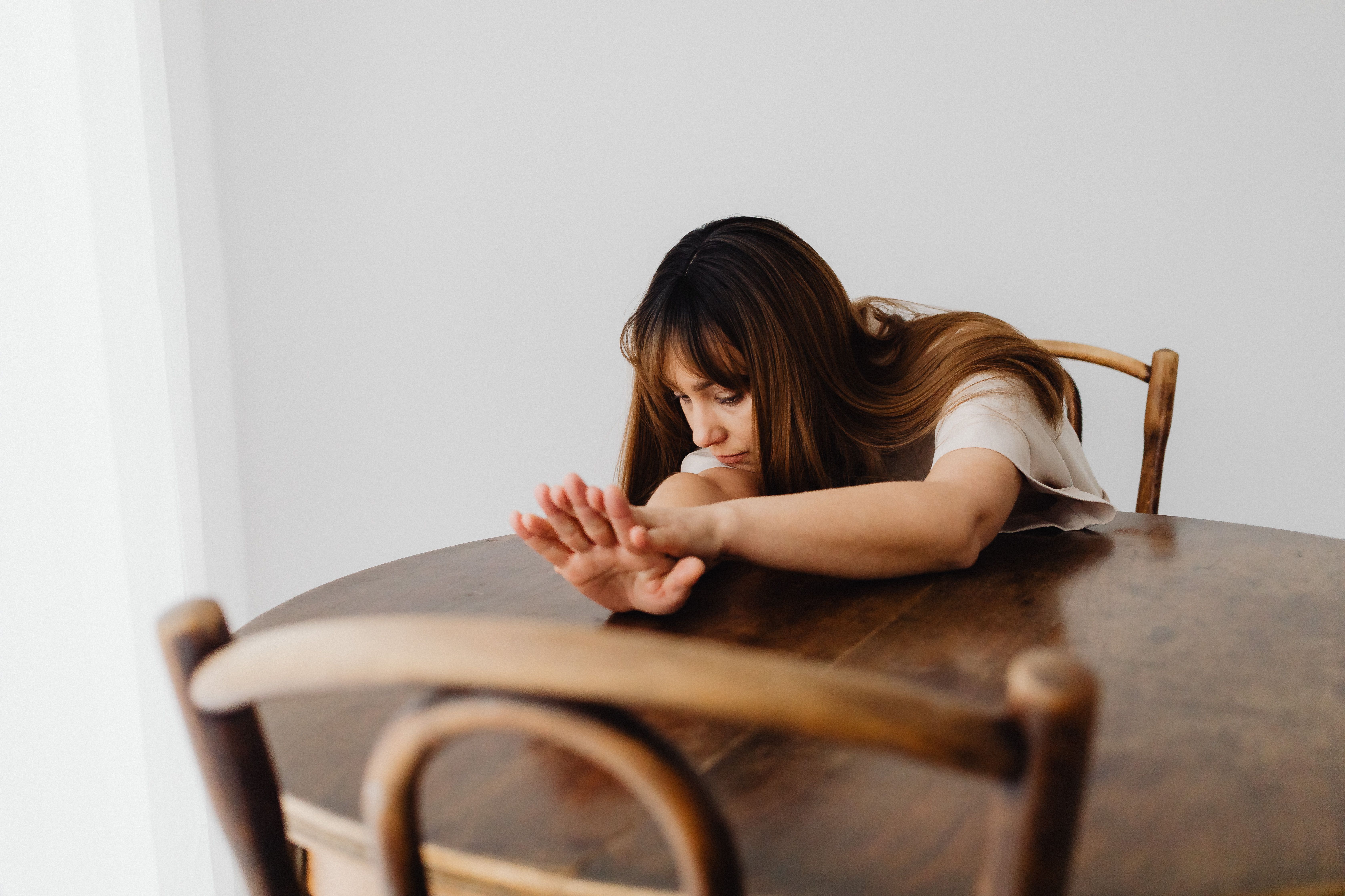 A Woman Crying Near the Wooden Table while Looking at the Ring · Free ...