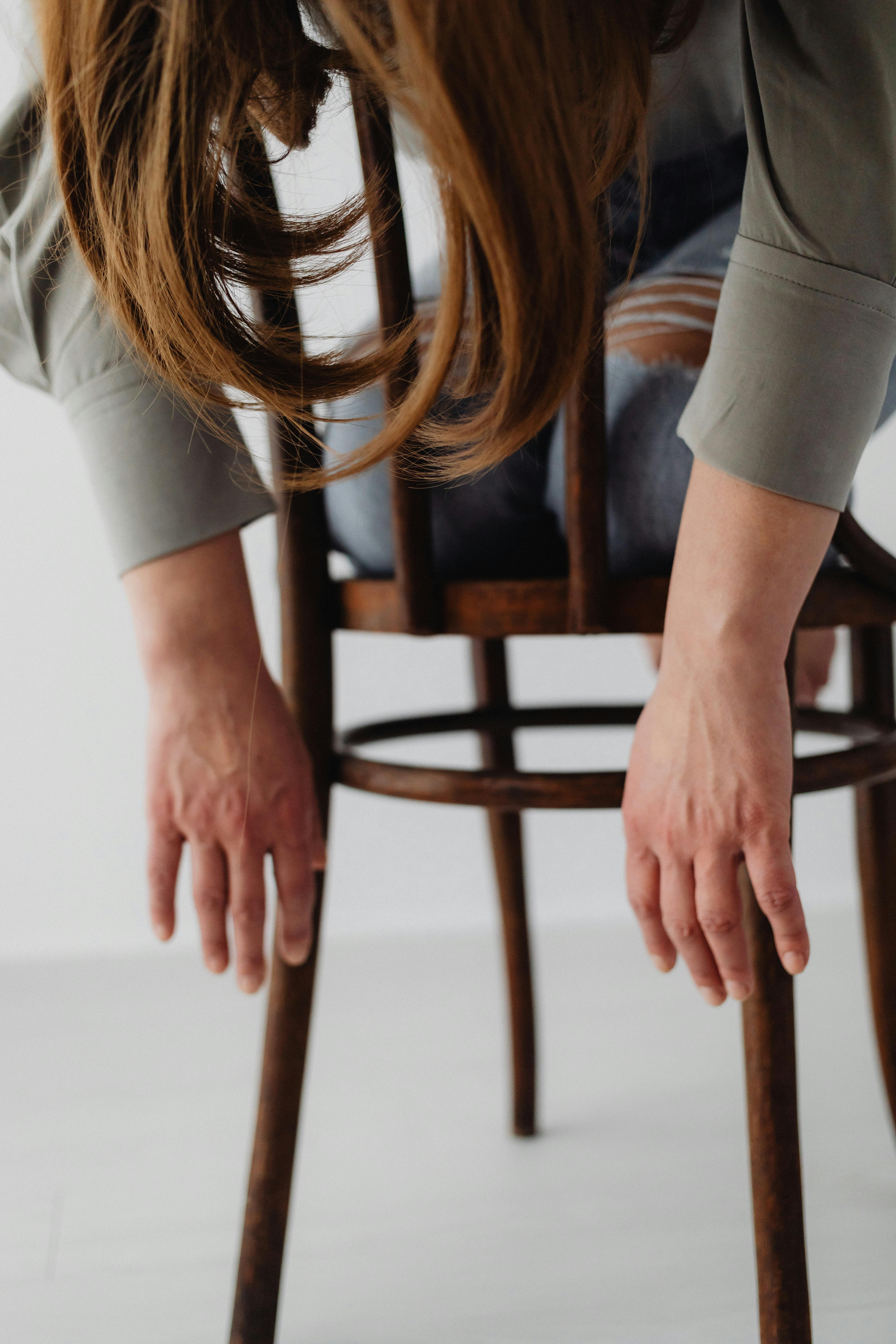 Hands Hanging from a Chair · Free Stock Photo