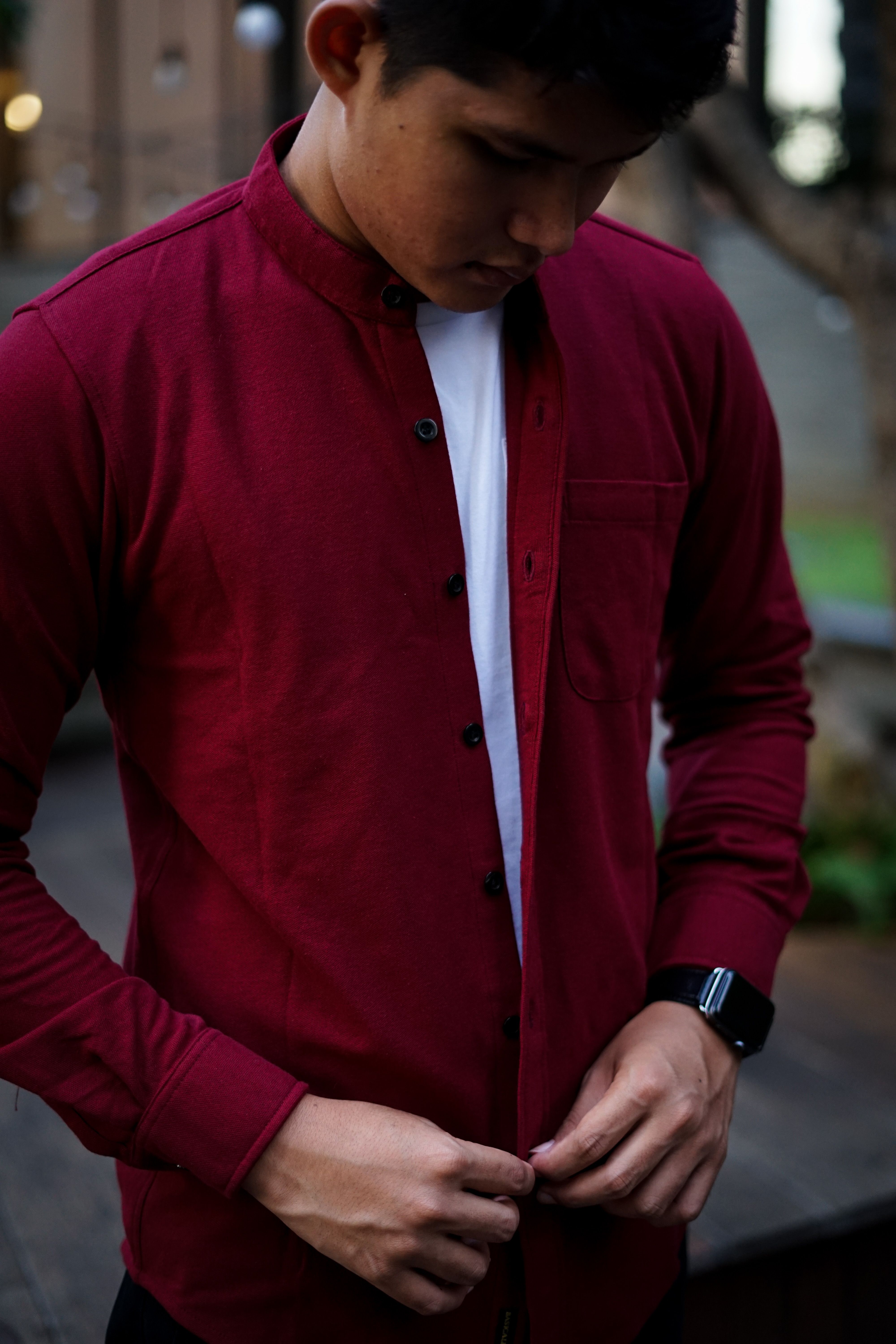 Man Putting on a Red Long Sleeves · Free Stock Photo