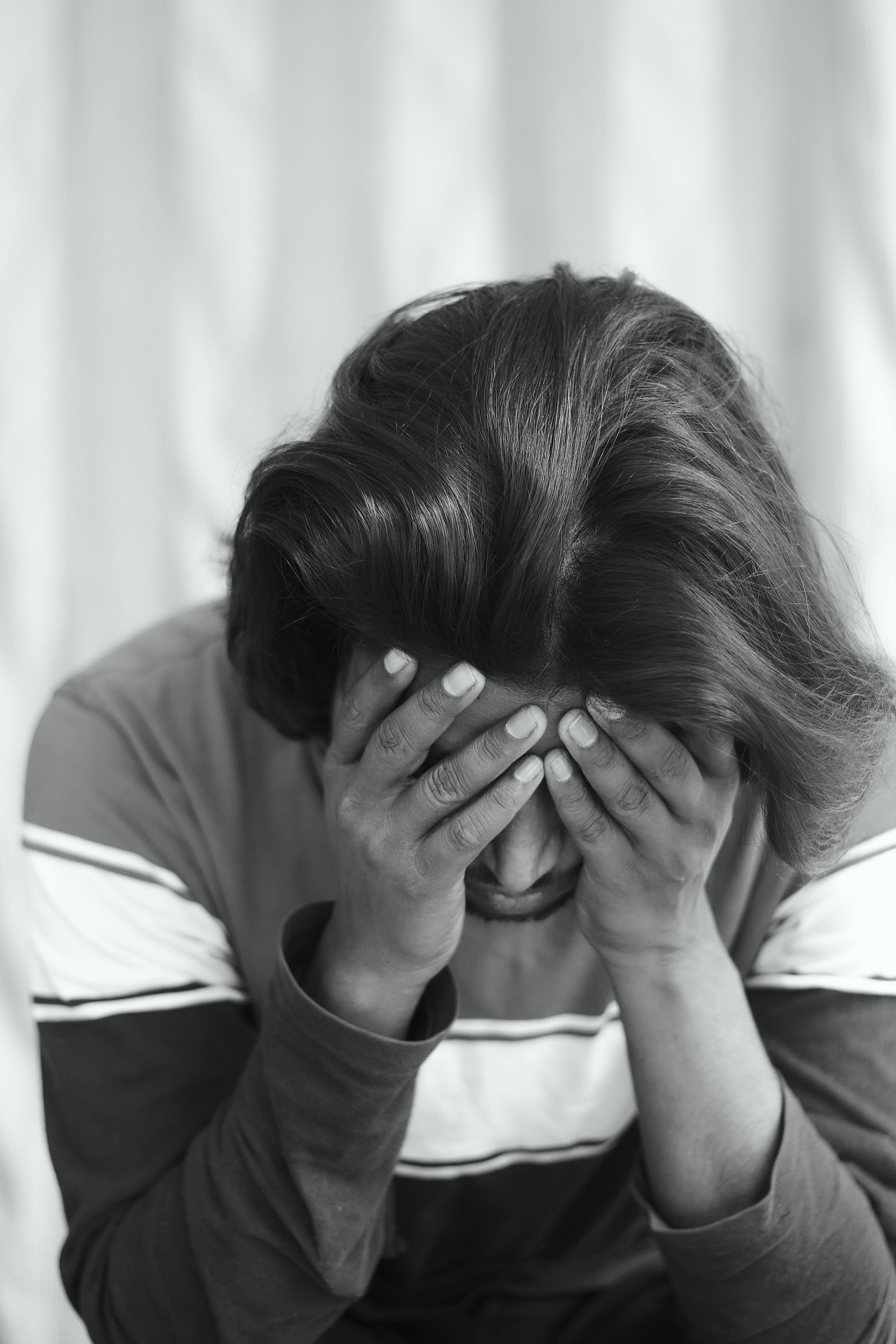 A Man Holding His Face · Free Stock Photo