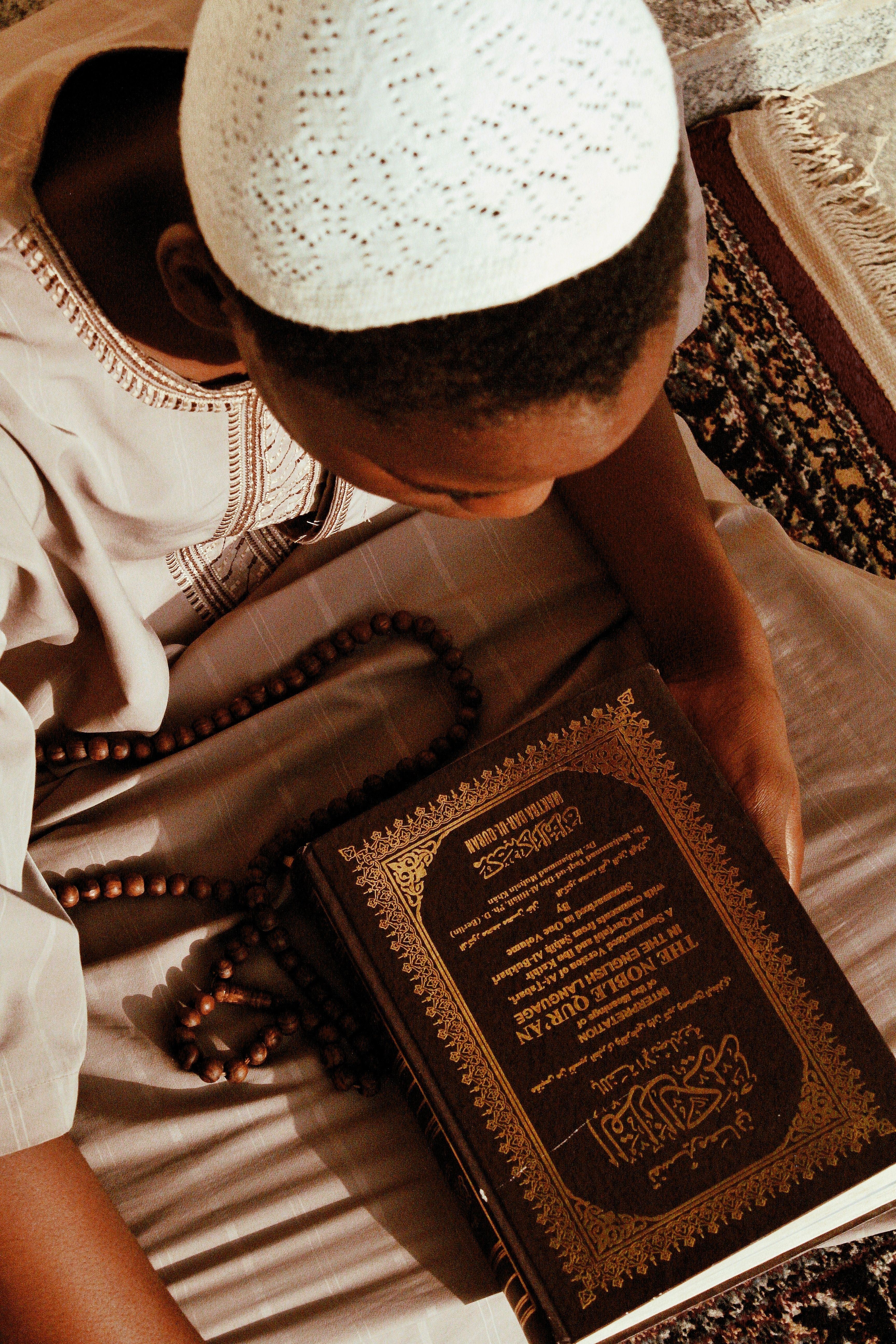 Black man reading Islamic sacred book · Free Stock Photo
