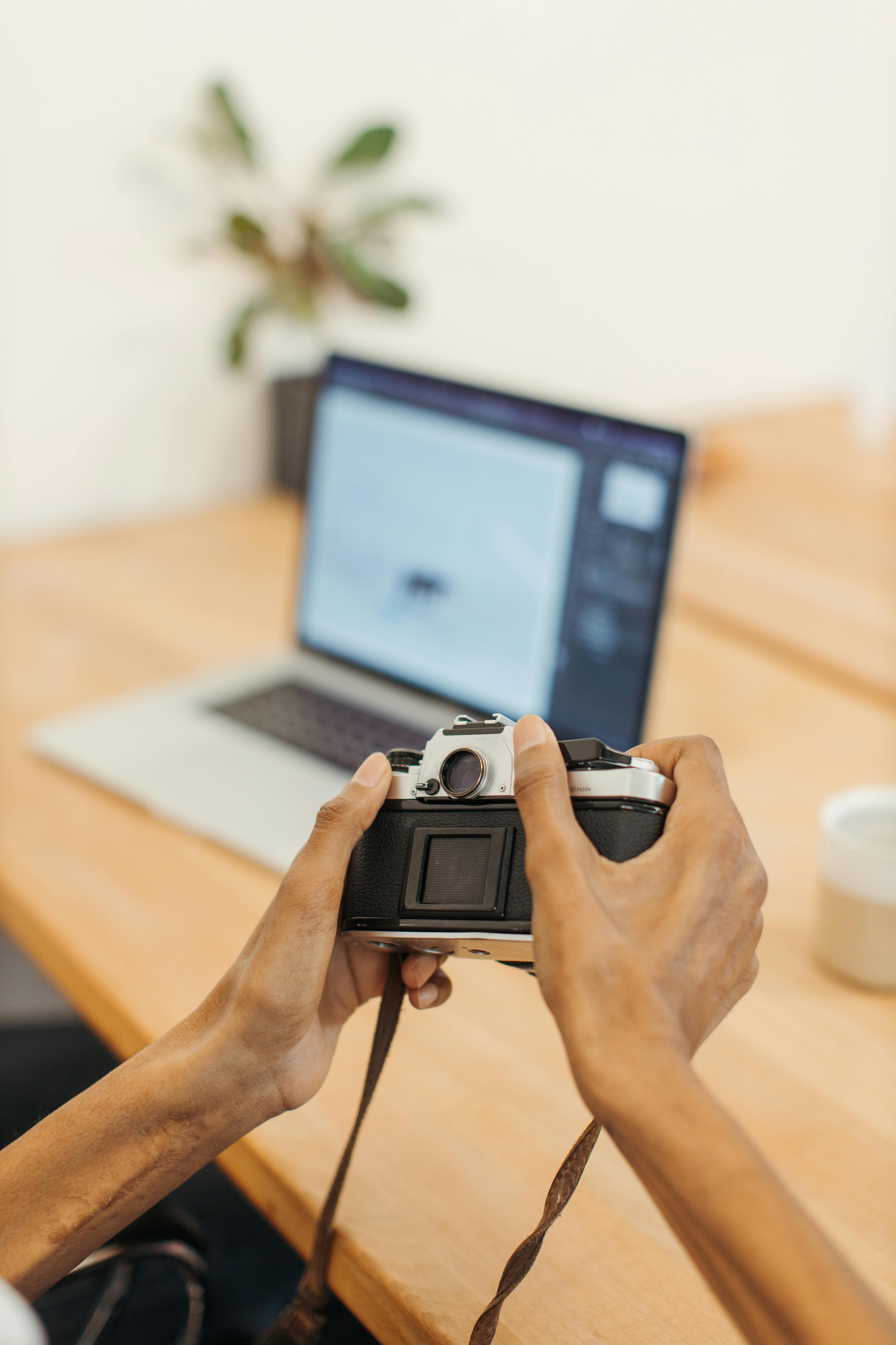 Close-Up Shot of a Person Holding a Camera · Free Stock Photo