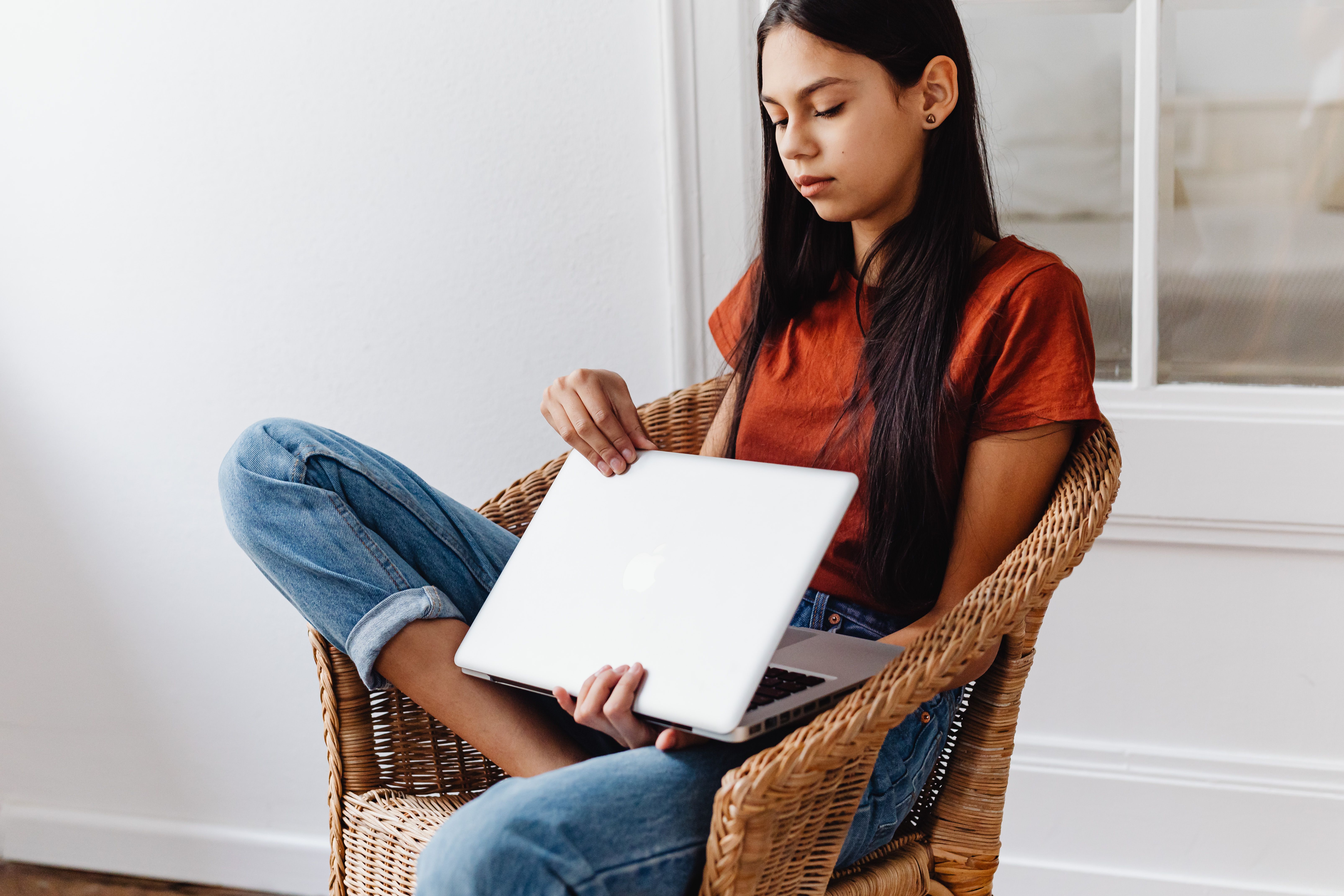 Girl Sitting on a Chair while Holding Her Laptop · Free Stock Photo