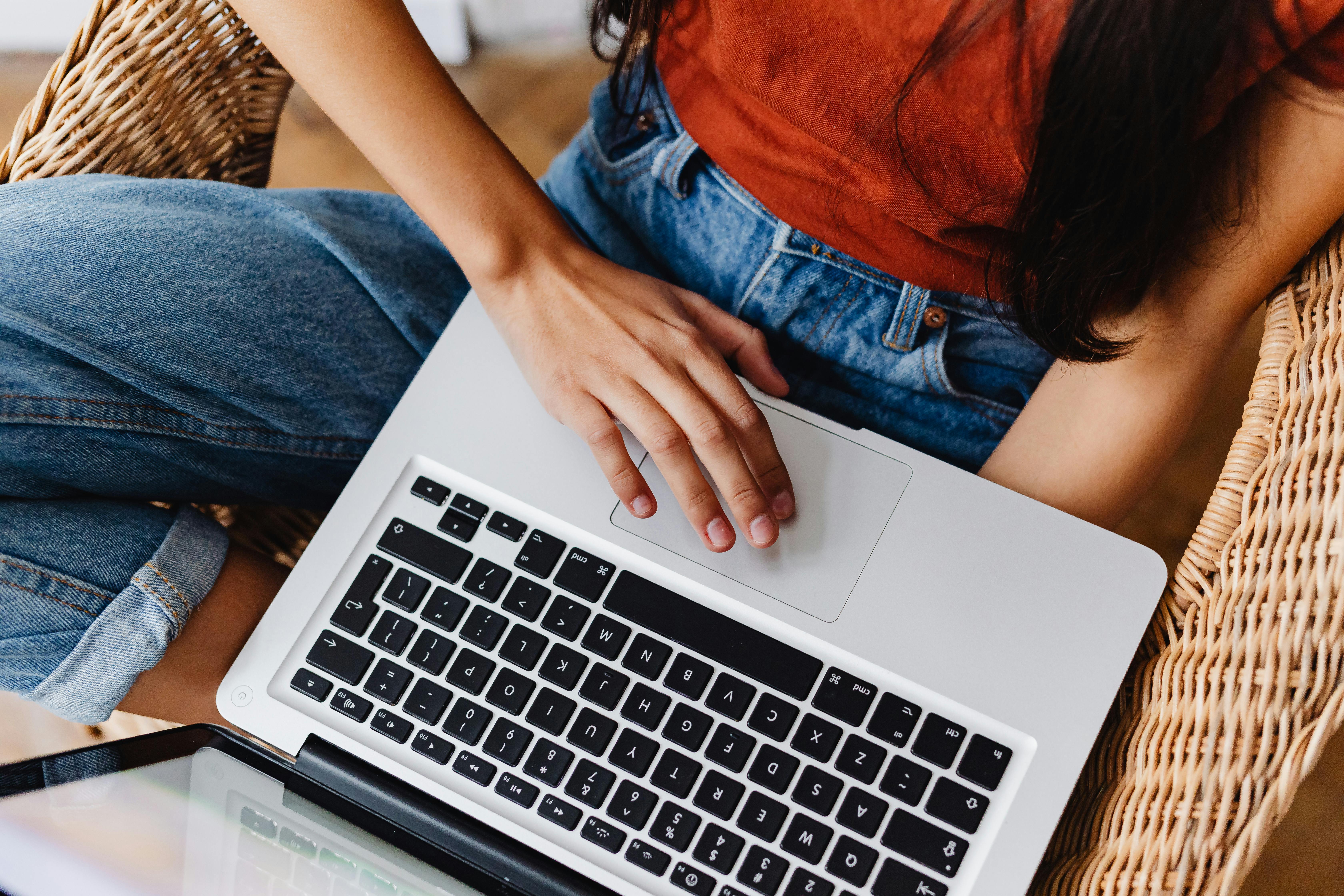 Close-Up Shot of a Person Using a MacBook · Free Stock Photo