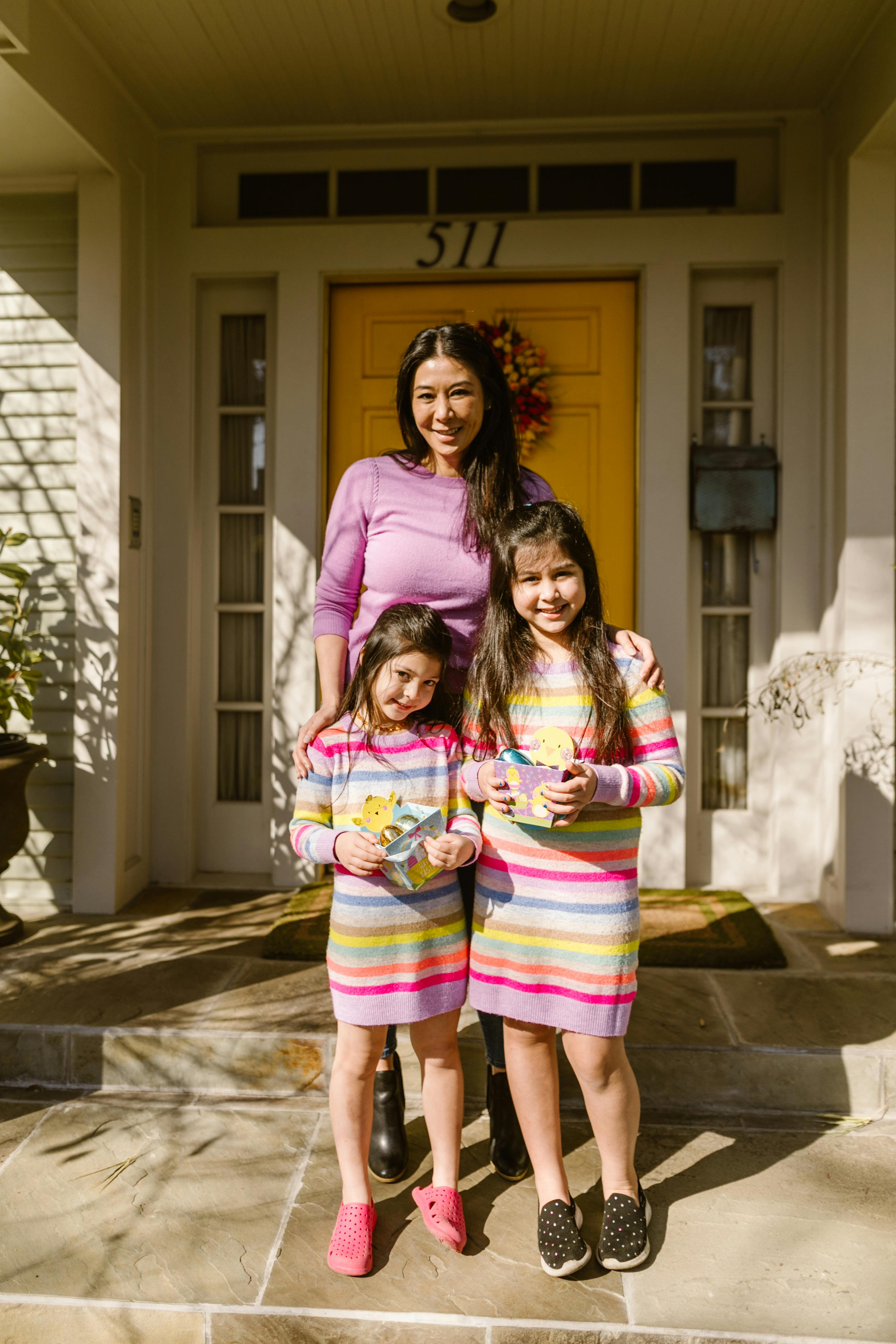 A Happy Family Sitting at the Front Door · Free Stock Photo