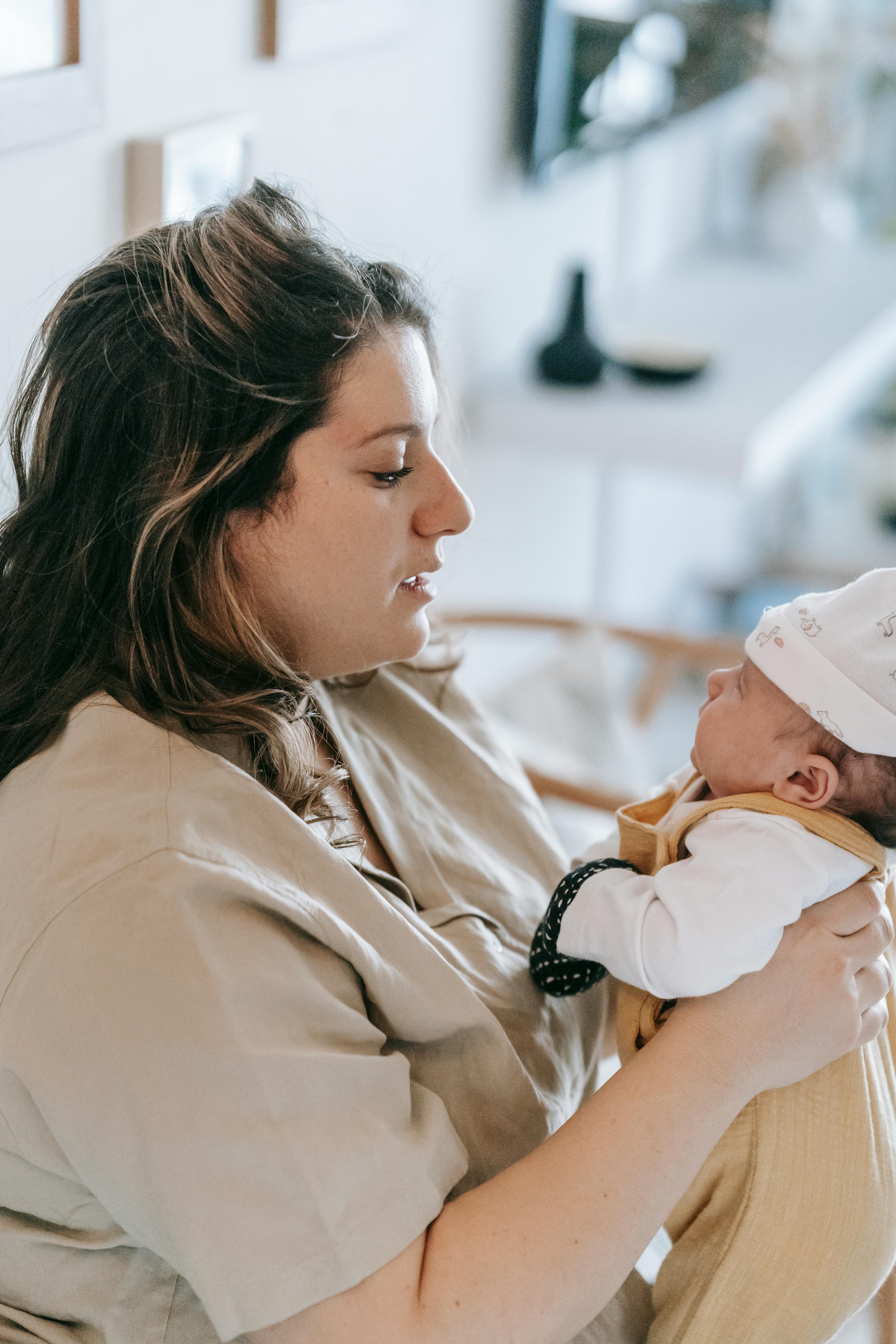 Faceless parent dressing infant baby · Free Stock Photo