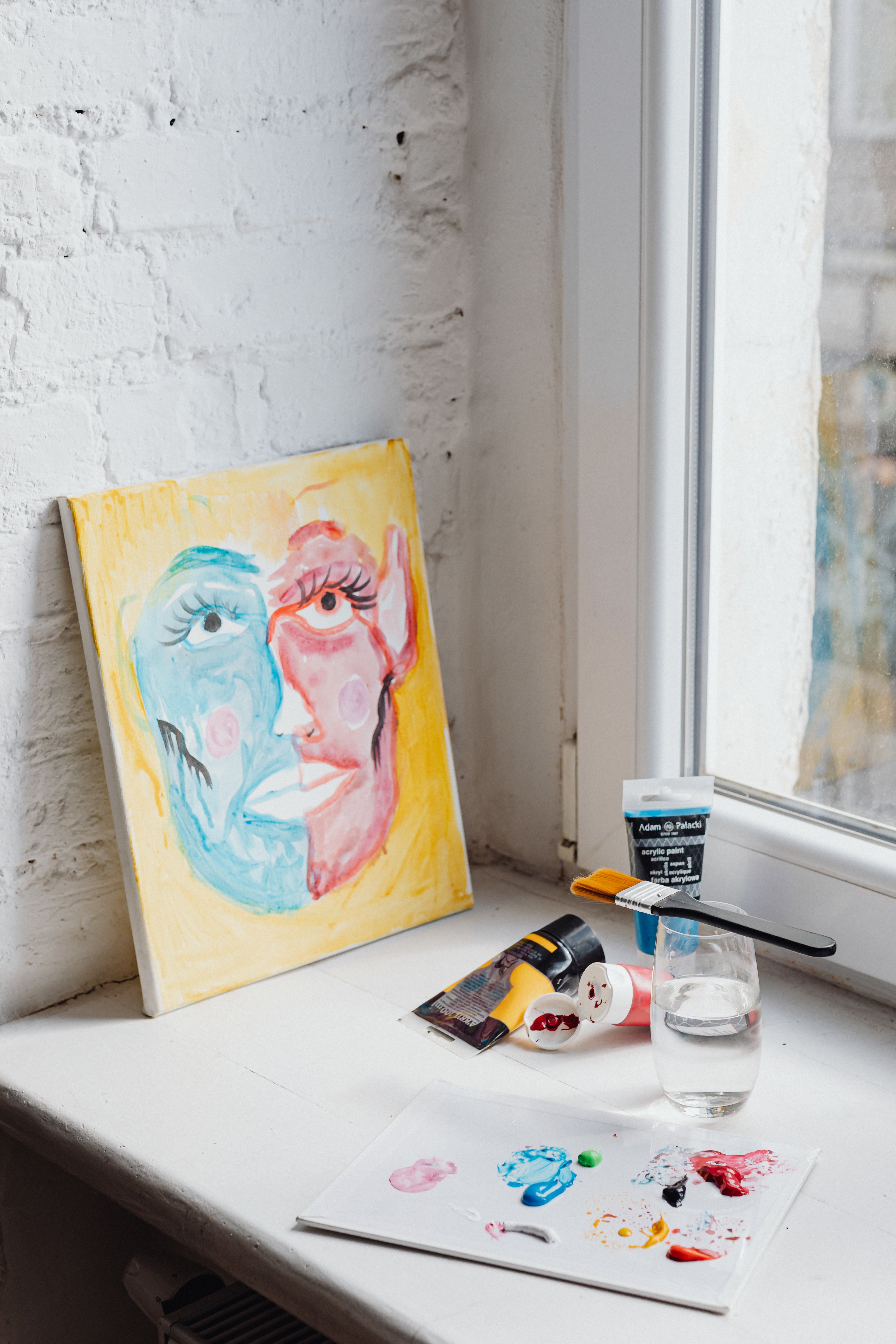 Colorful Artwork Near Painting Materials · Free Stock Photo