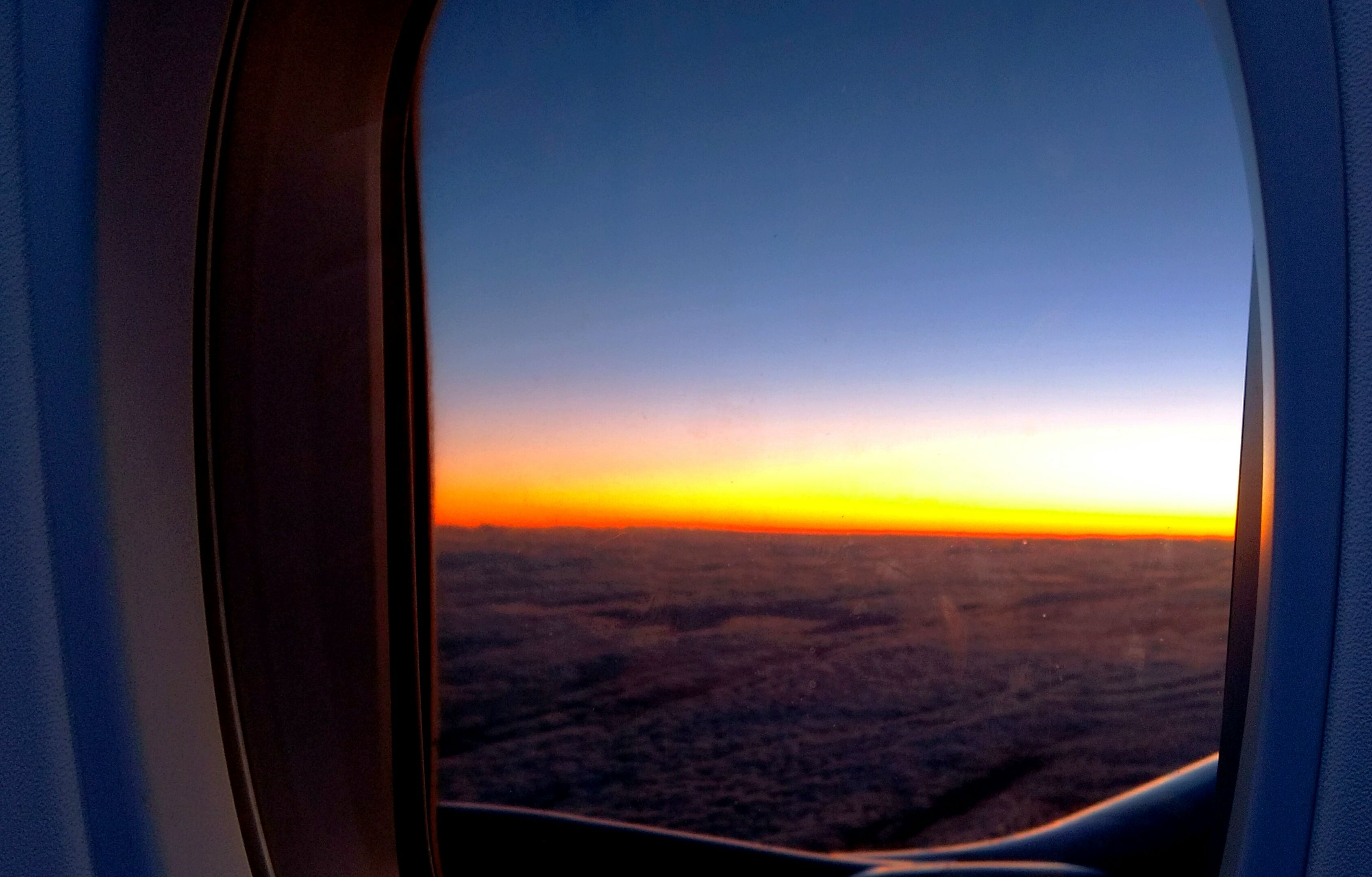 Photo Of Airplane Window With View Of Clouds And Golden Hour Free