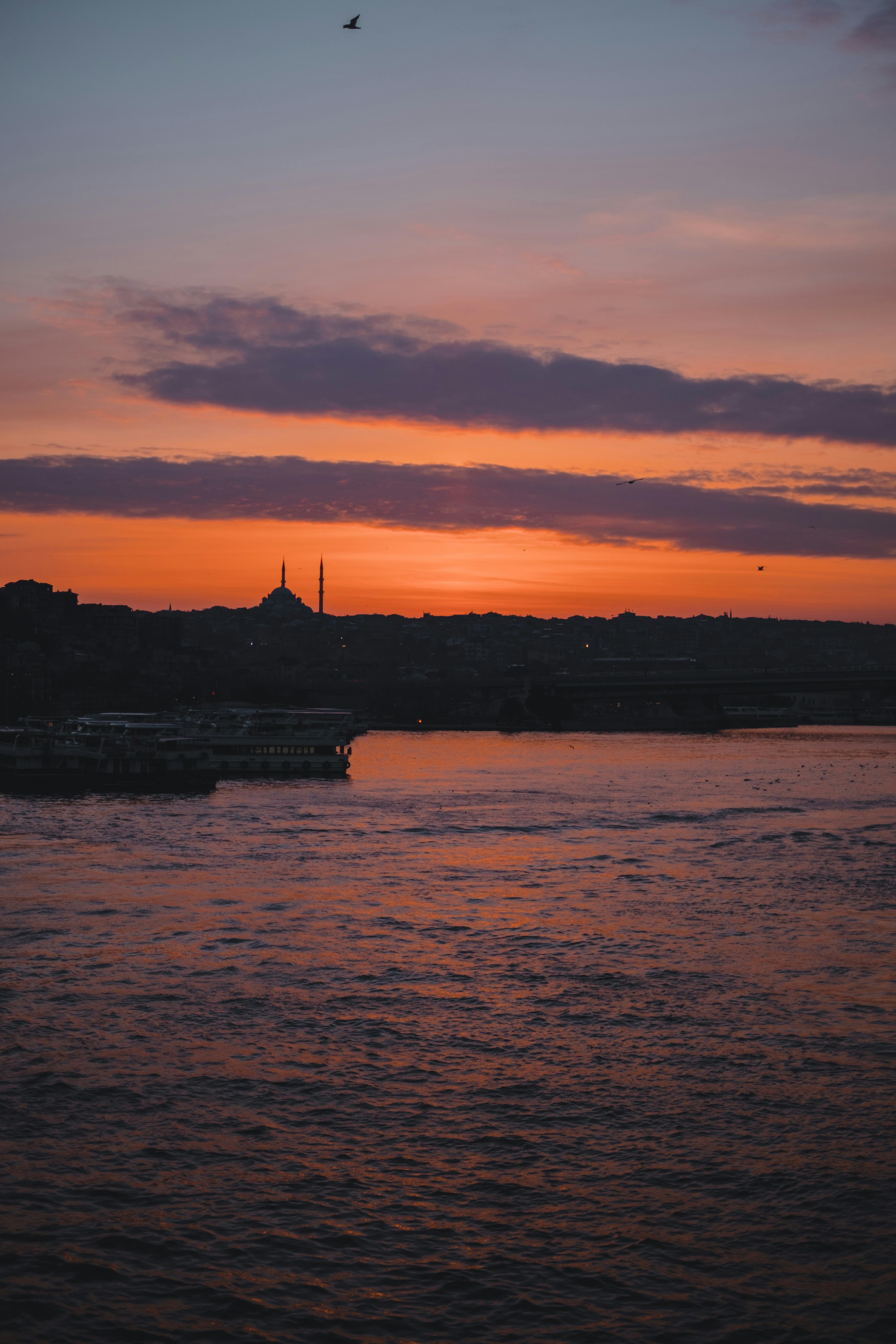 Calm sea and mountains at sunset time · Free Stock Photo