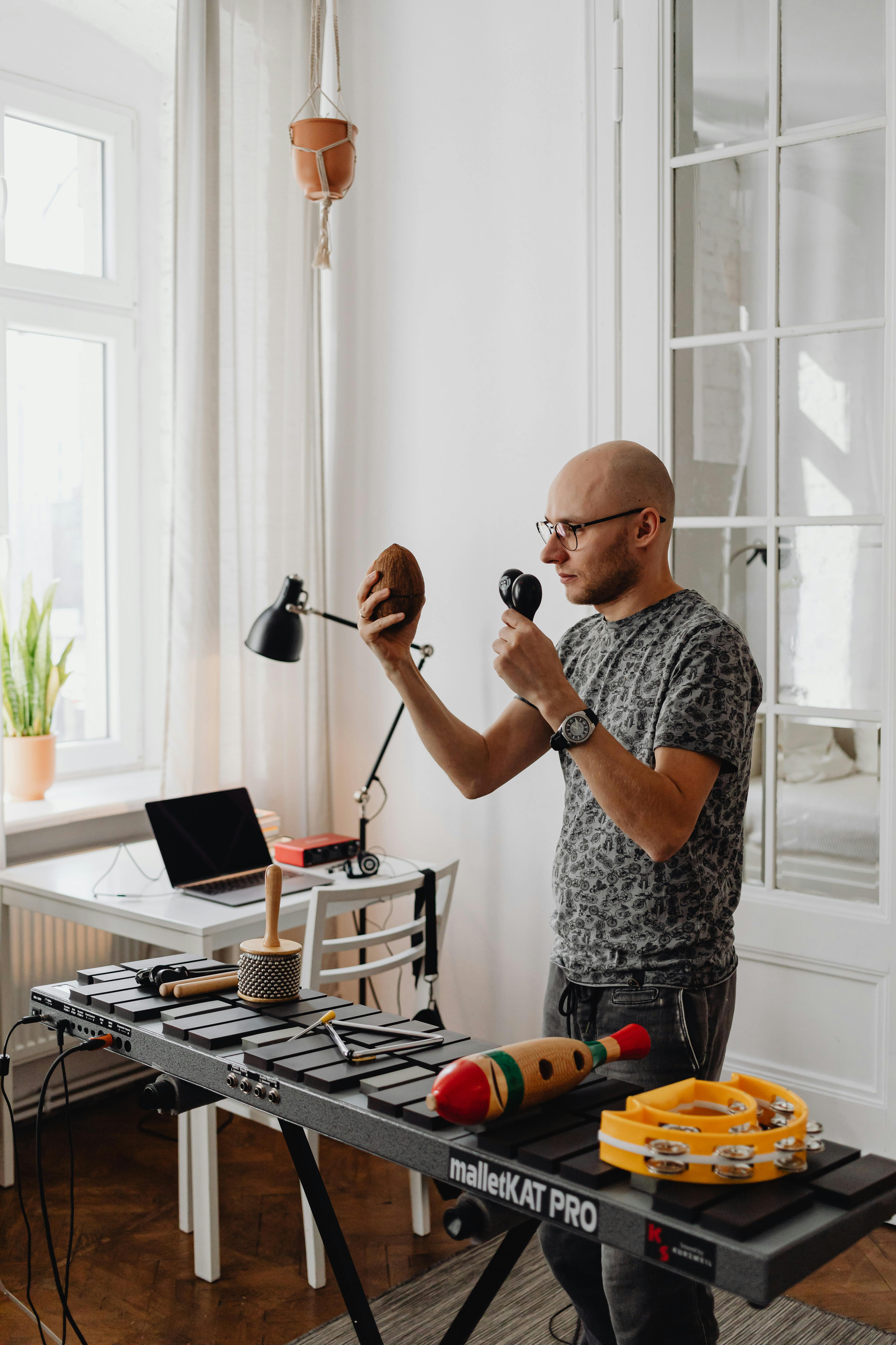 Man with Keyboard in Room · Free Stock Photo