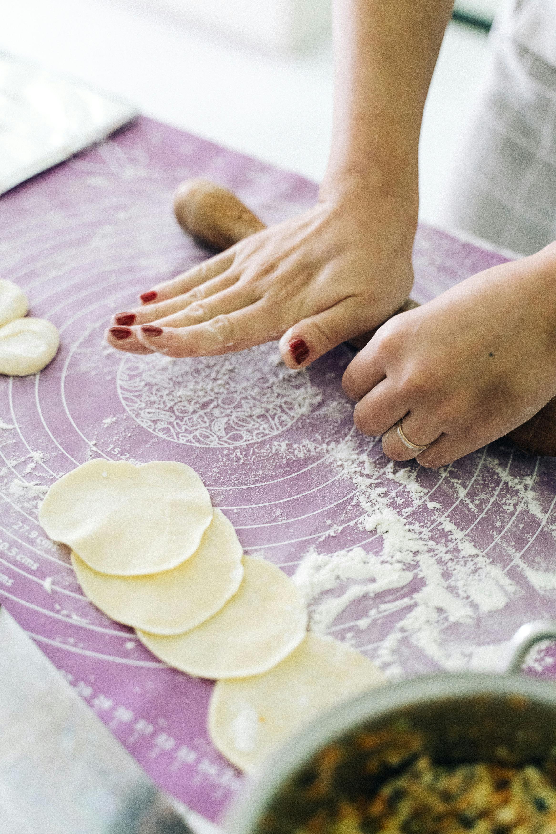 A Person Making Dumpling Wrappers · Free Stock Photo