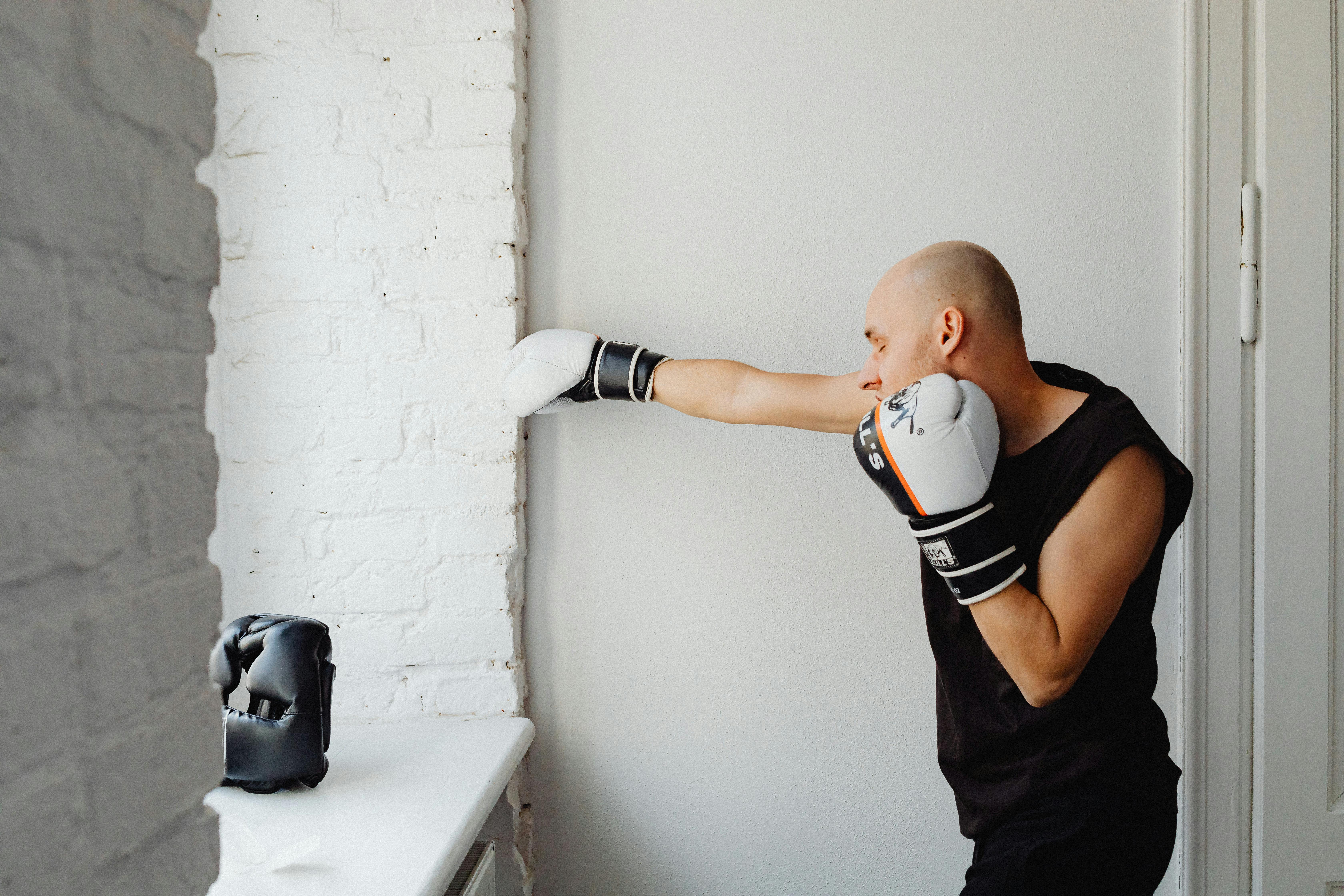 A Man Punching the Wall · Free Stock Photo