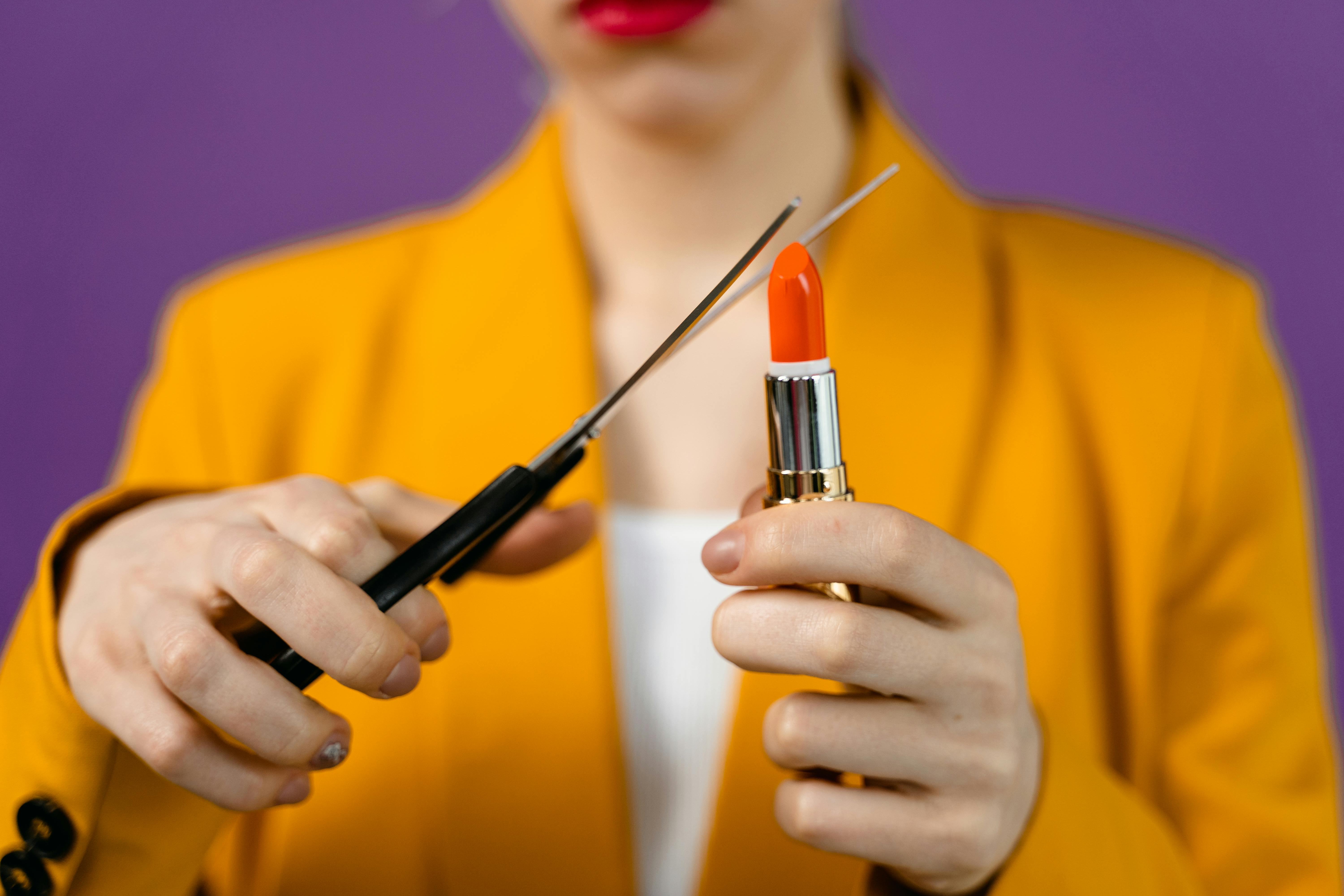 A Person Cutting a Lipstick · Free Stock Photo