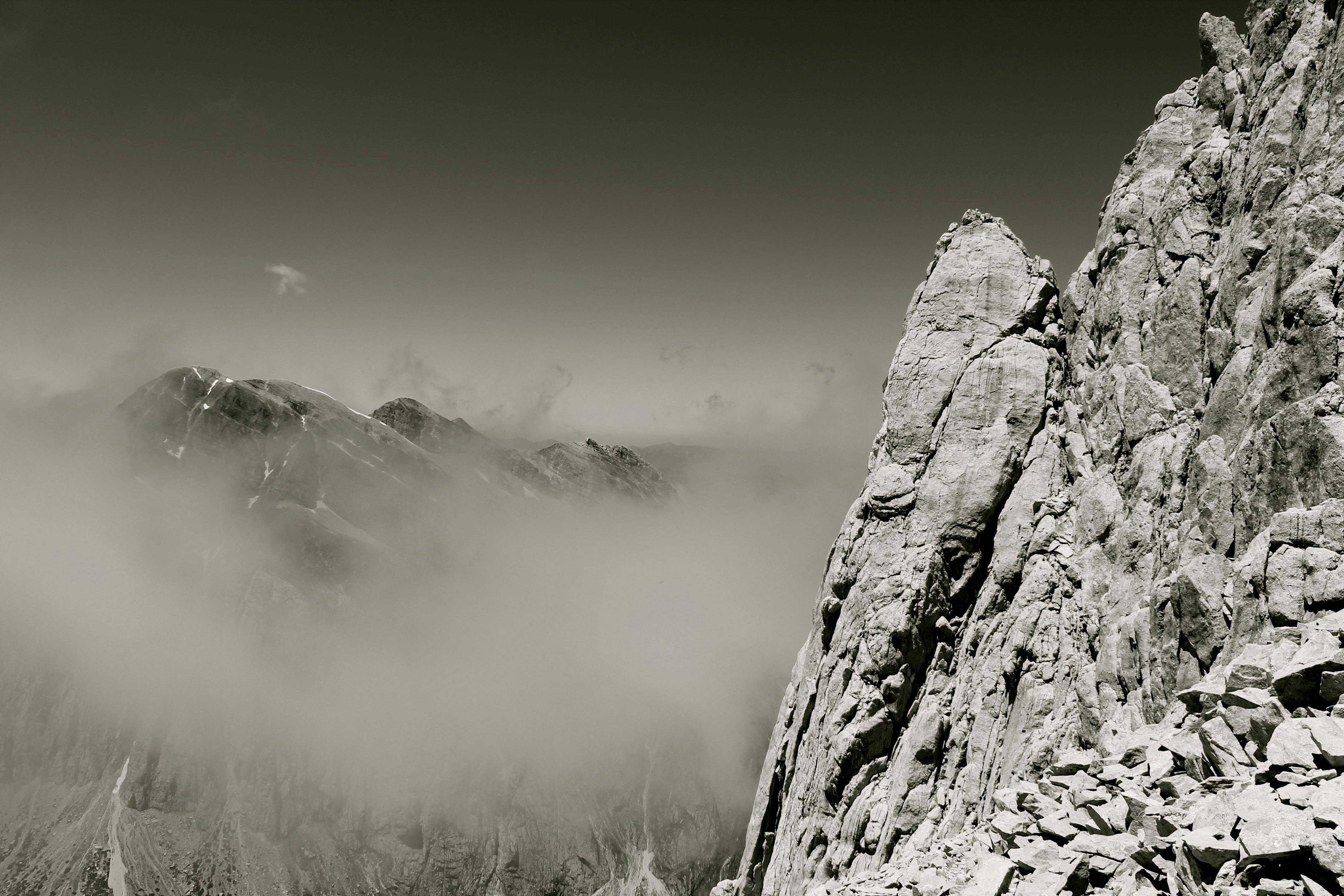 A Grayscale of a Mountain with Rock Formations · Free Stock Photo