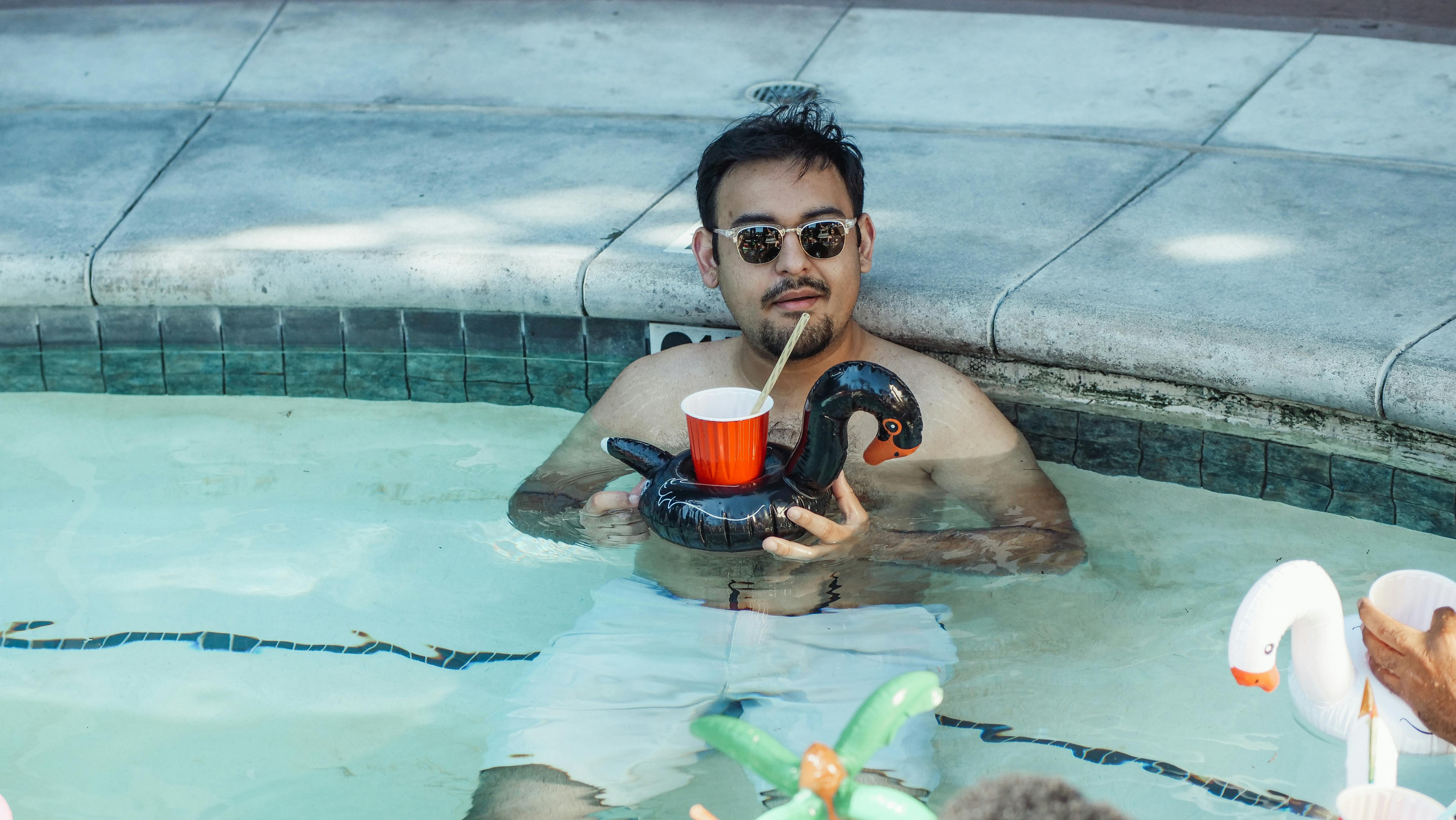 Man Swimming in the Pool while Drinking from the Plastic Cup · Free ...