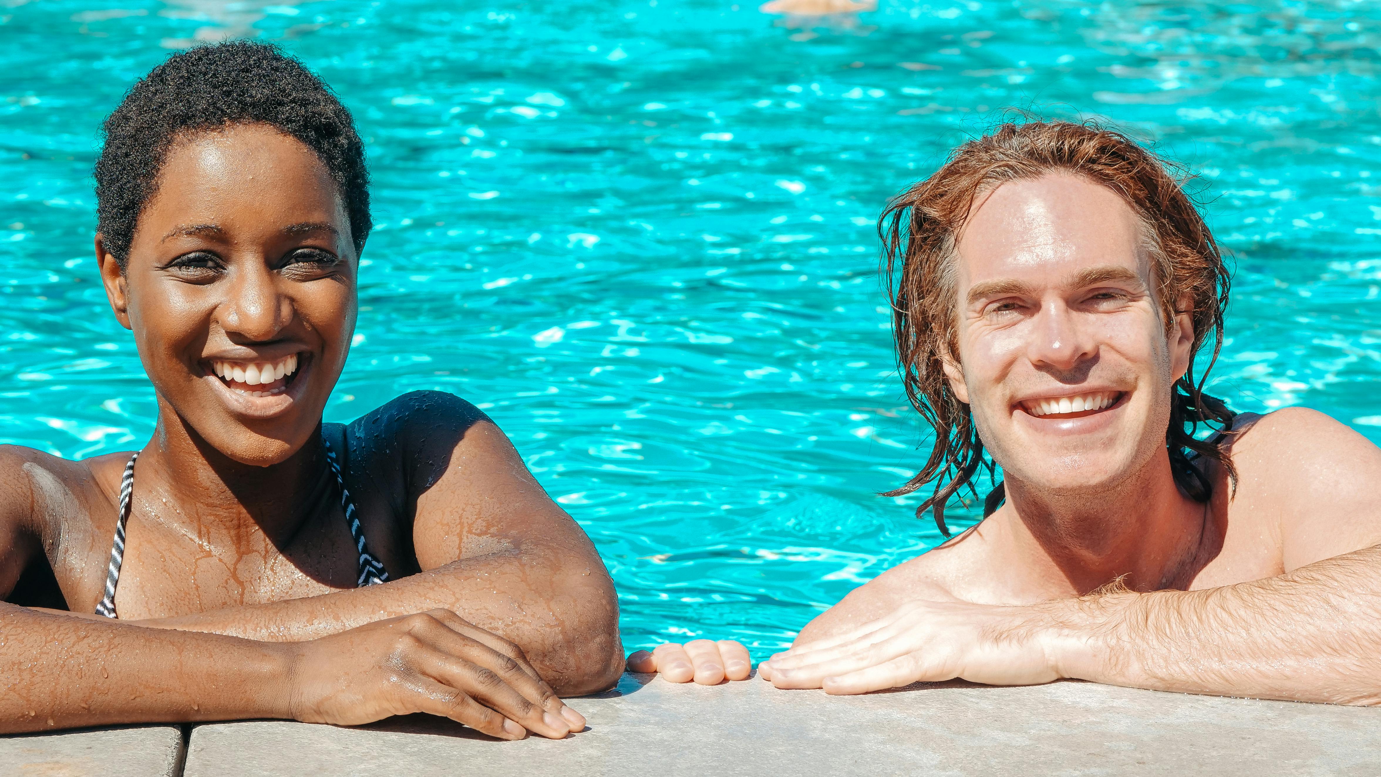 A Couple Embracing while in the Swimming Pool · Free Stock Photo