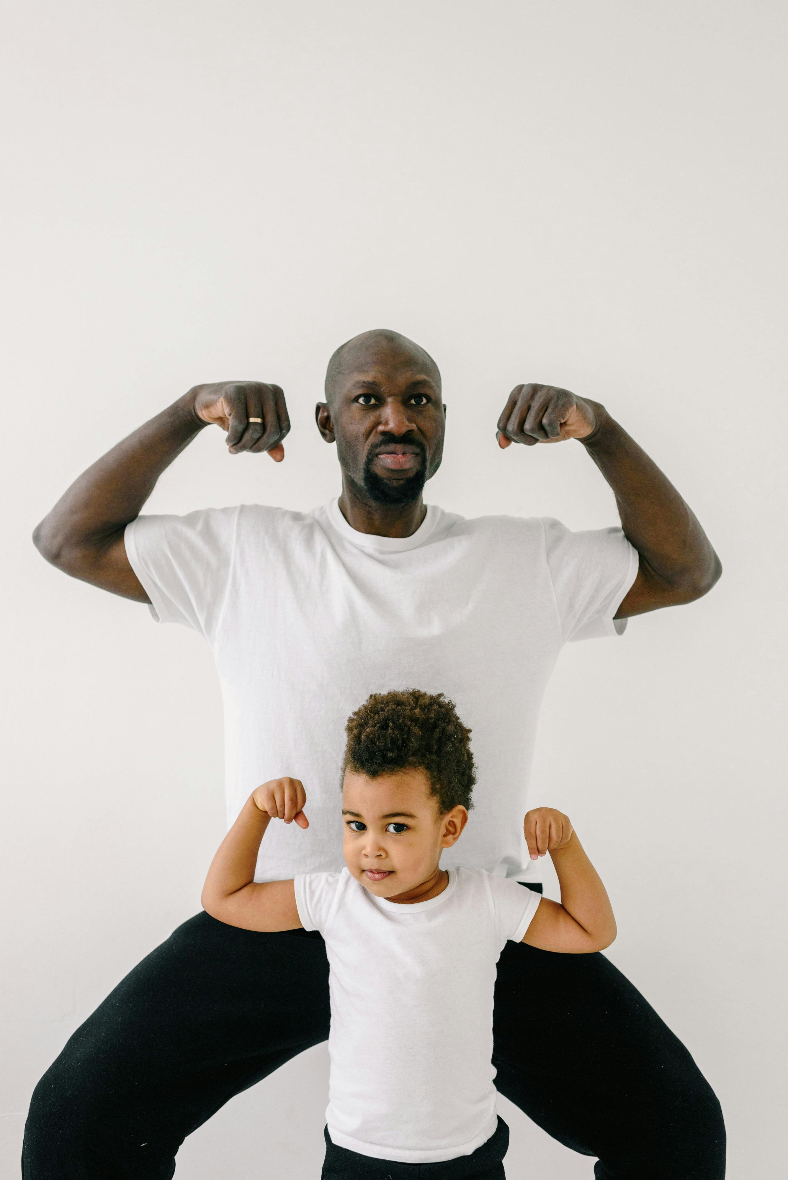 A Father and Son Showing Muscle Together · Free Stock Photo