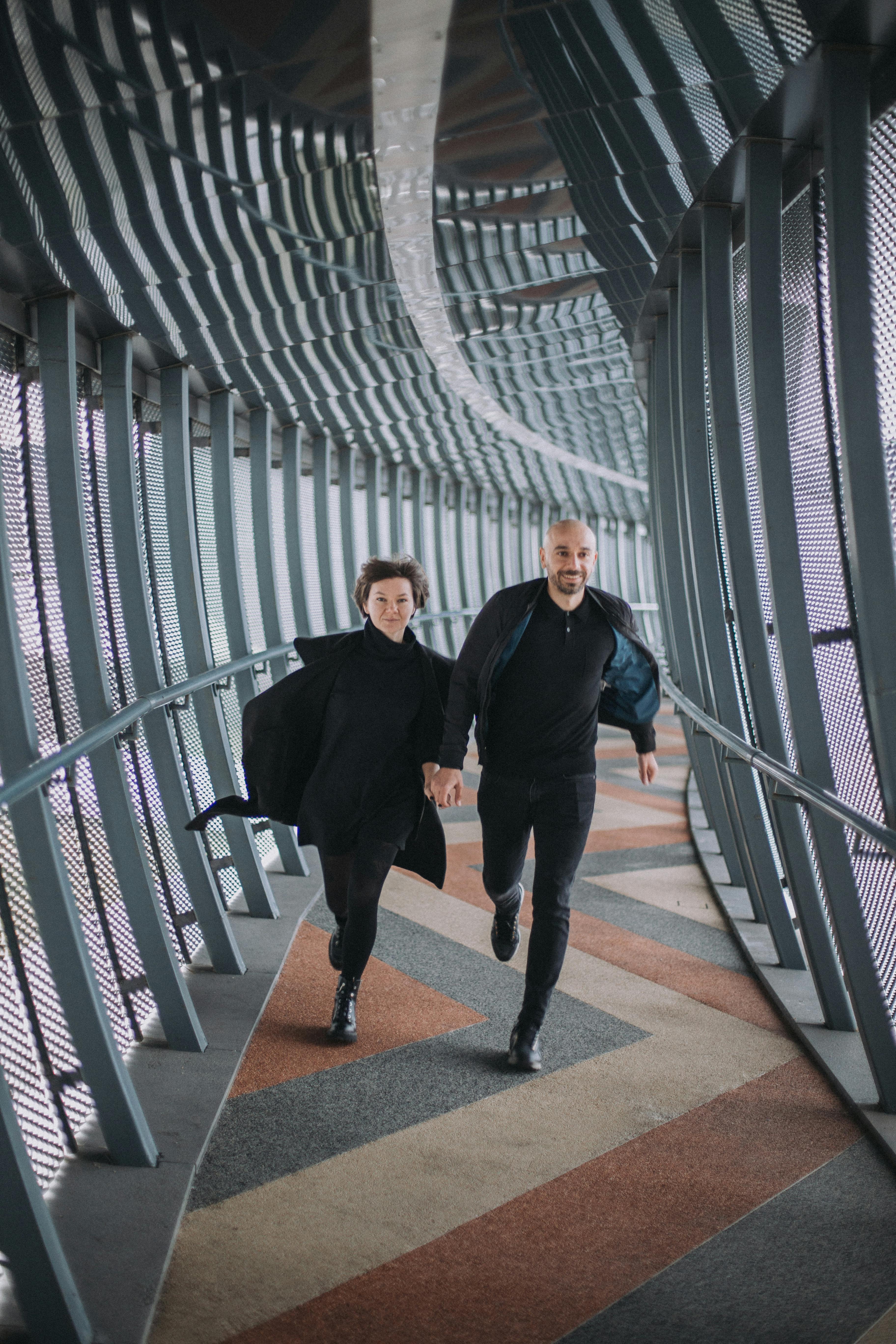 Couple Holding Hands While Running · Free Stock Photo