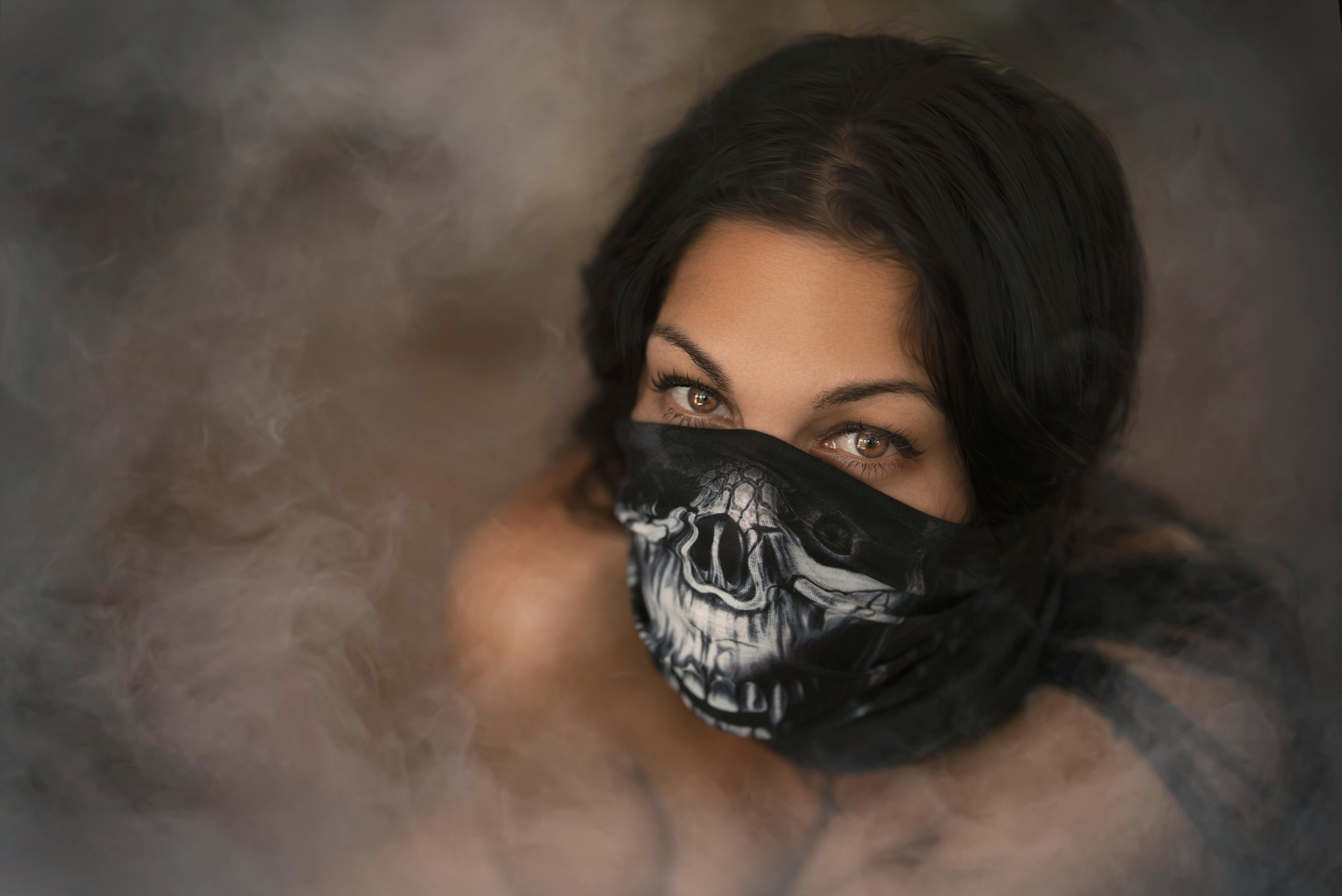 A Woman with Brown Eyes Wearing a Black Mask with a Skull Design · Free ...