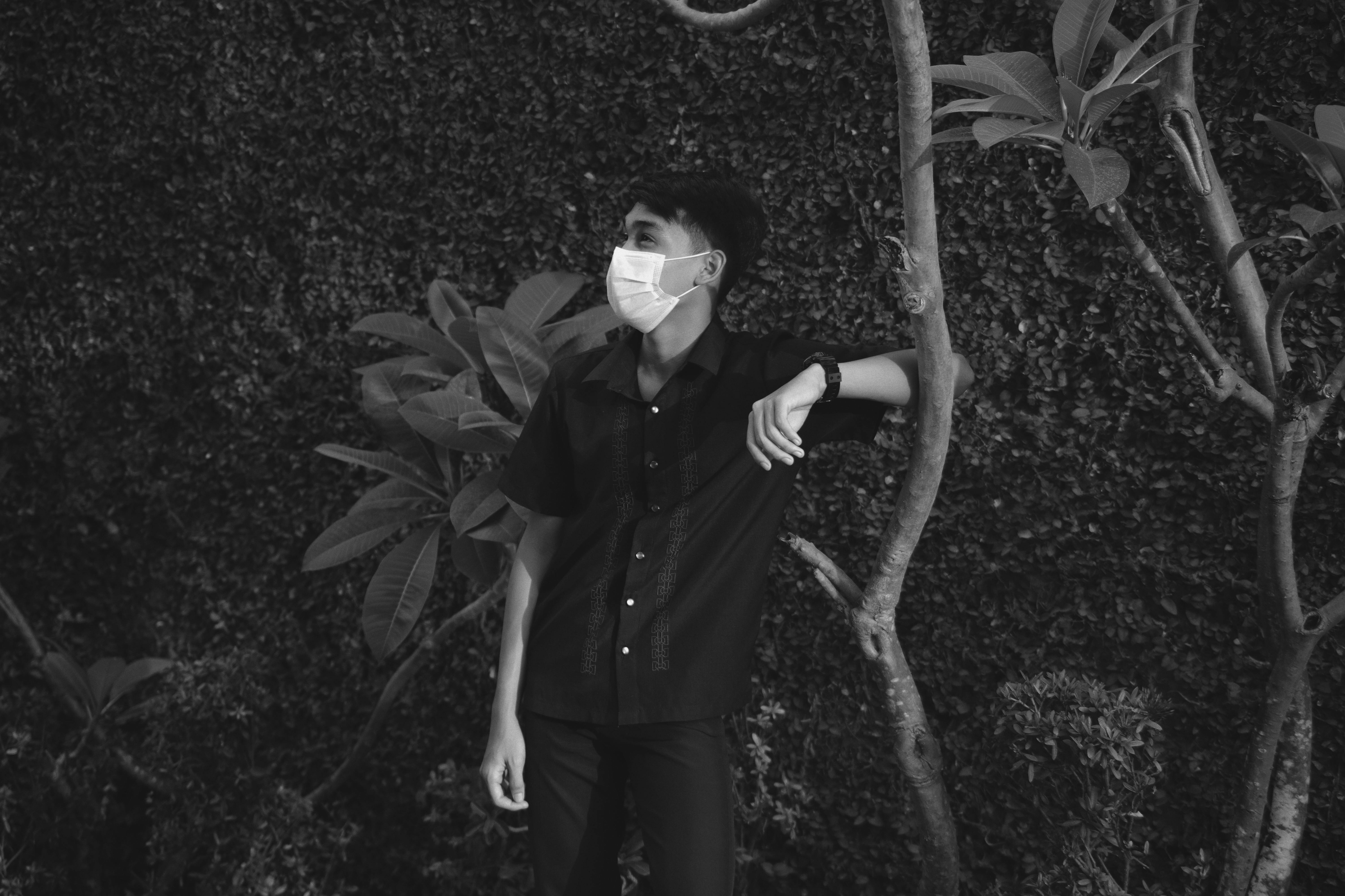 Grayscale Phot of People Wearing Masks in a Crowd · Free Stock Photo