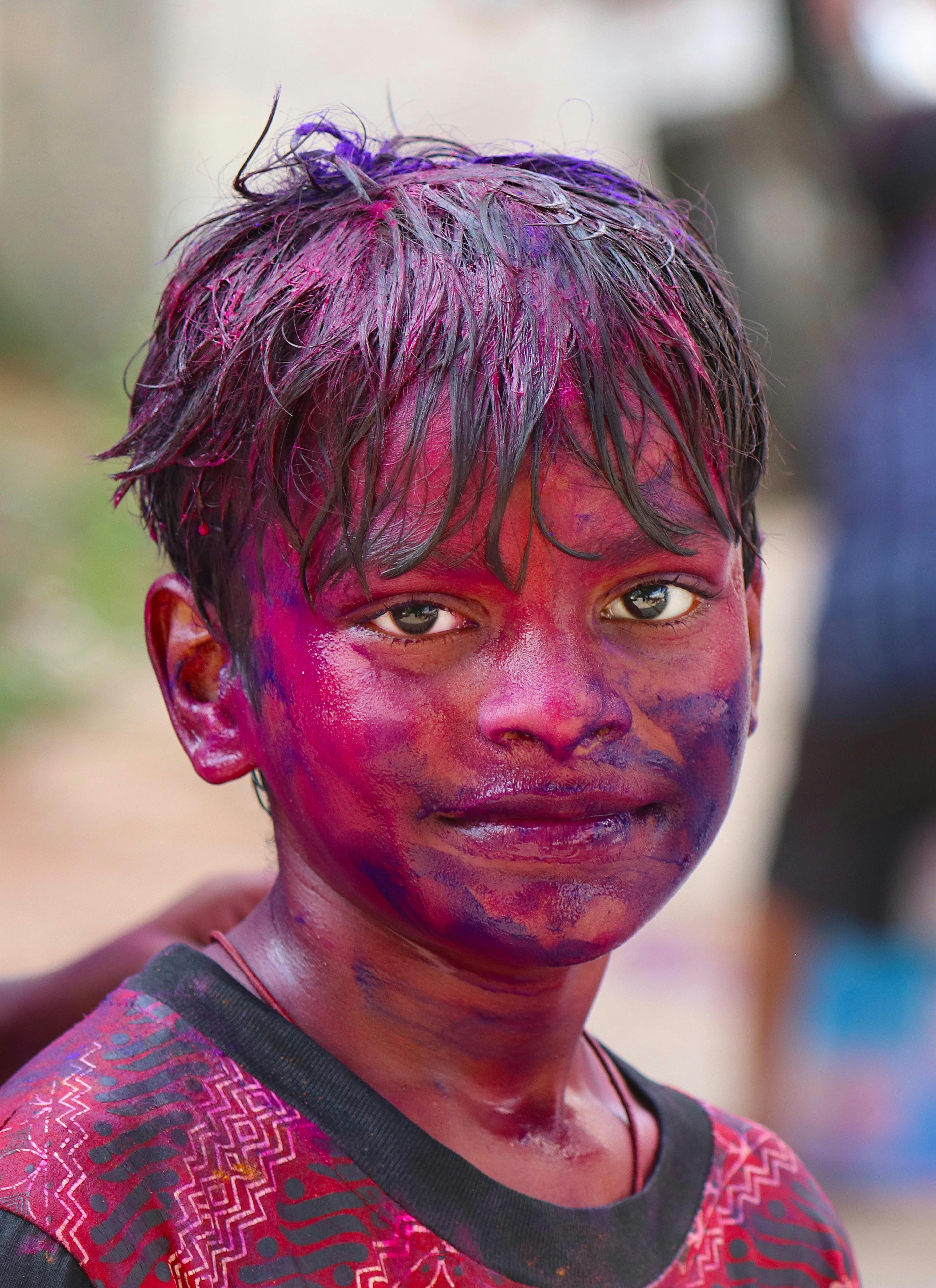 A Boy with Paint on His Face Smiling at the Camera · Free Stock Photo