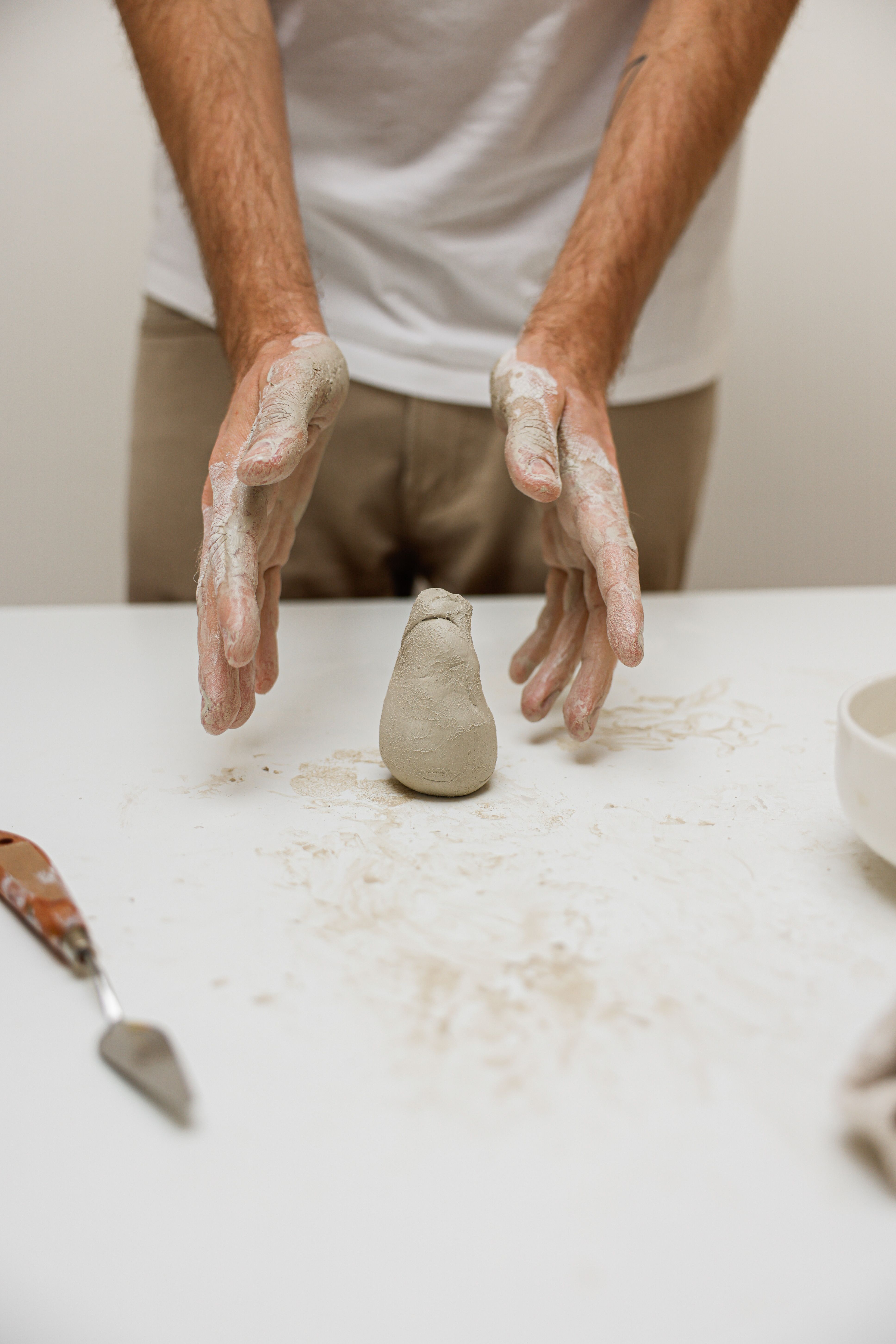 A Man Creating Something Out of Clay · Free Stock Photo