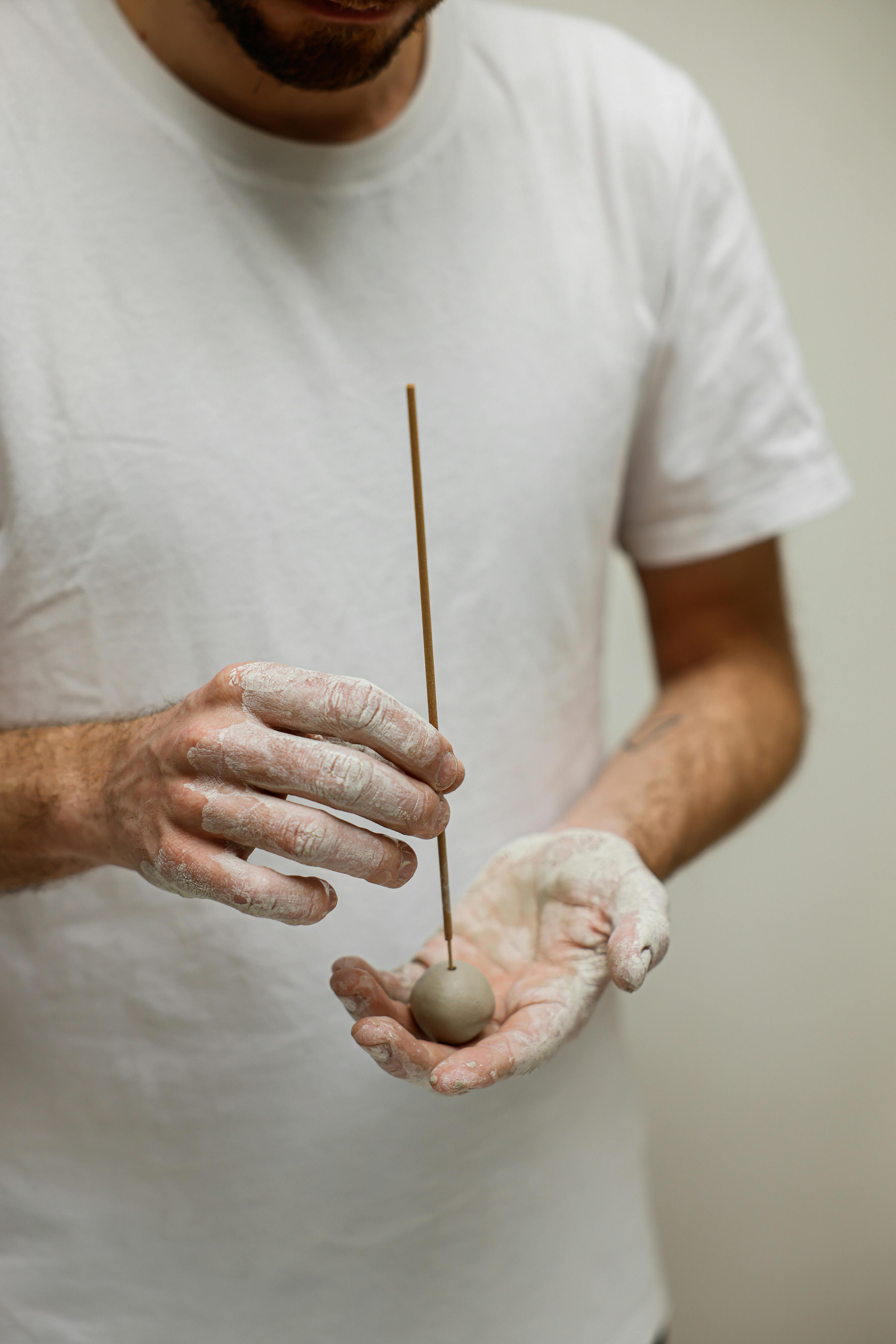 Man with Clay Ball and Stick · Free Stock Photo