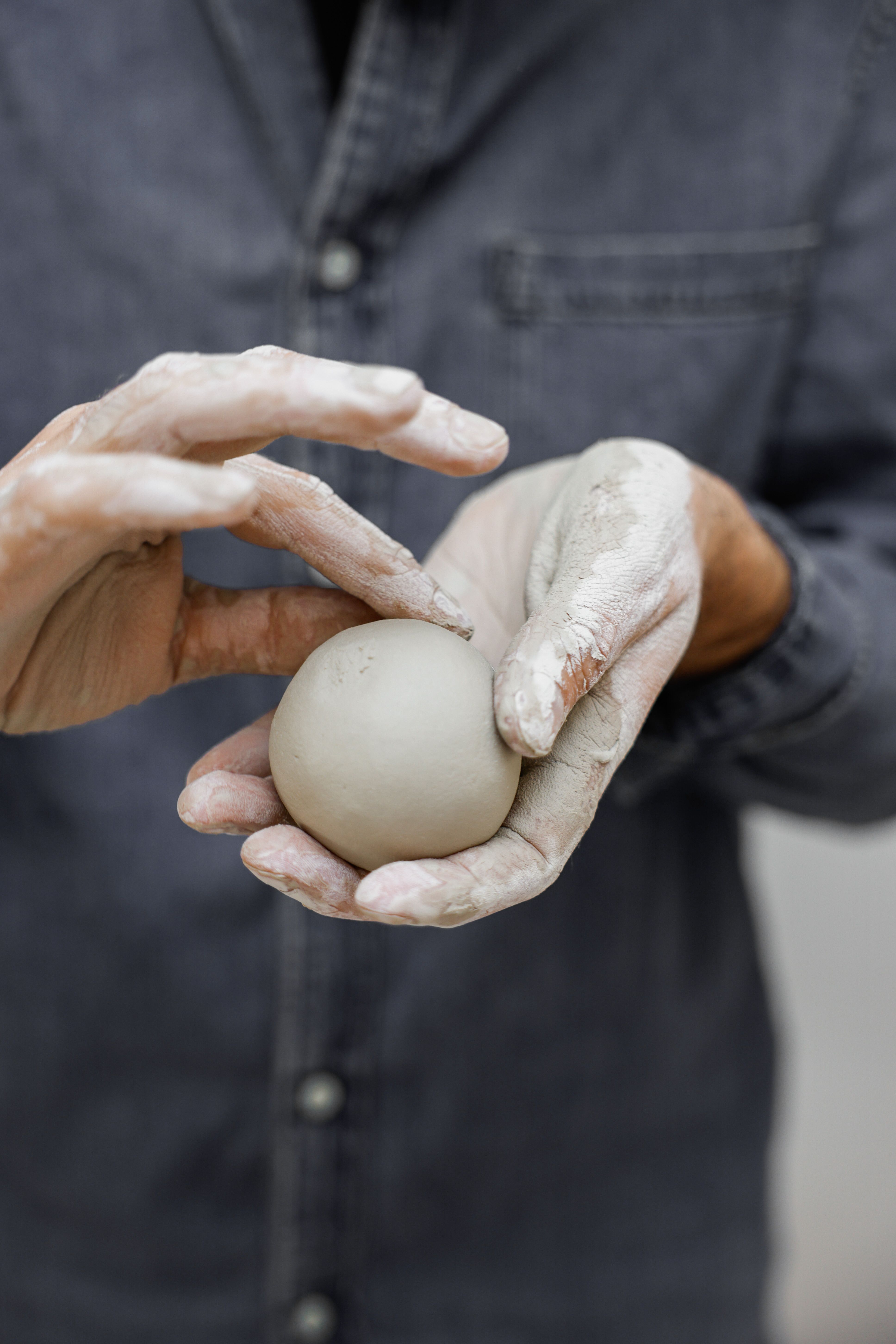Man Holding Raw Clay · Free Stock Photo