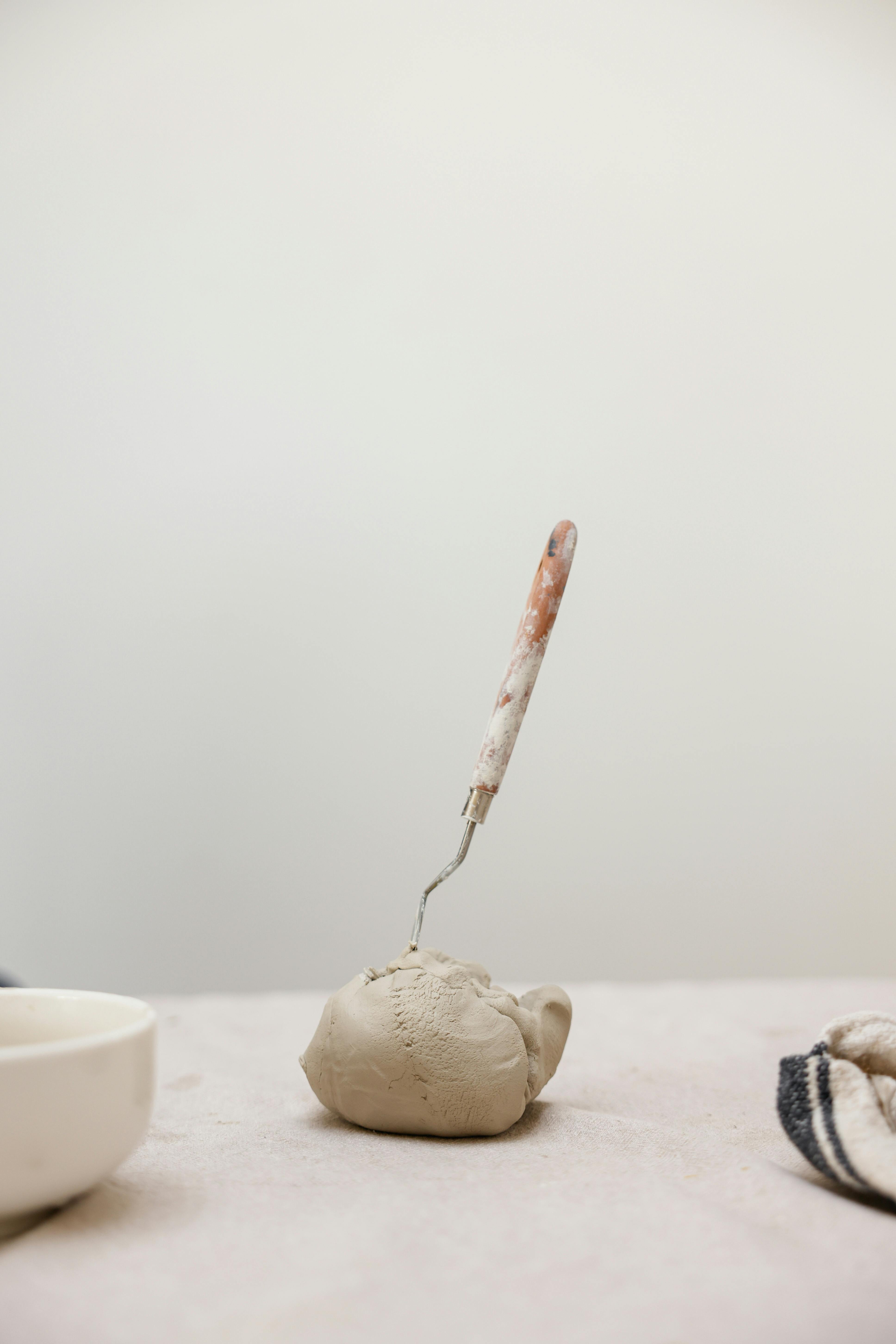A Ball of Clay with a Spatula Stuck in It · Free Stock Photo