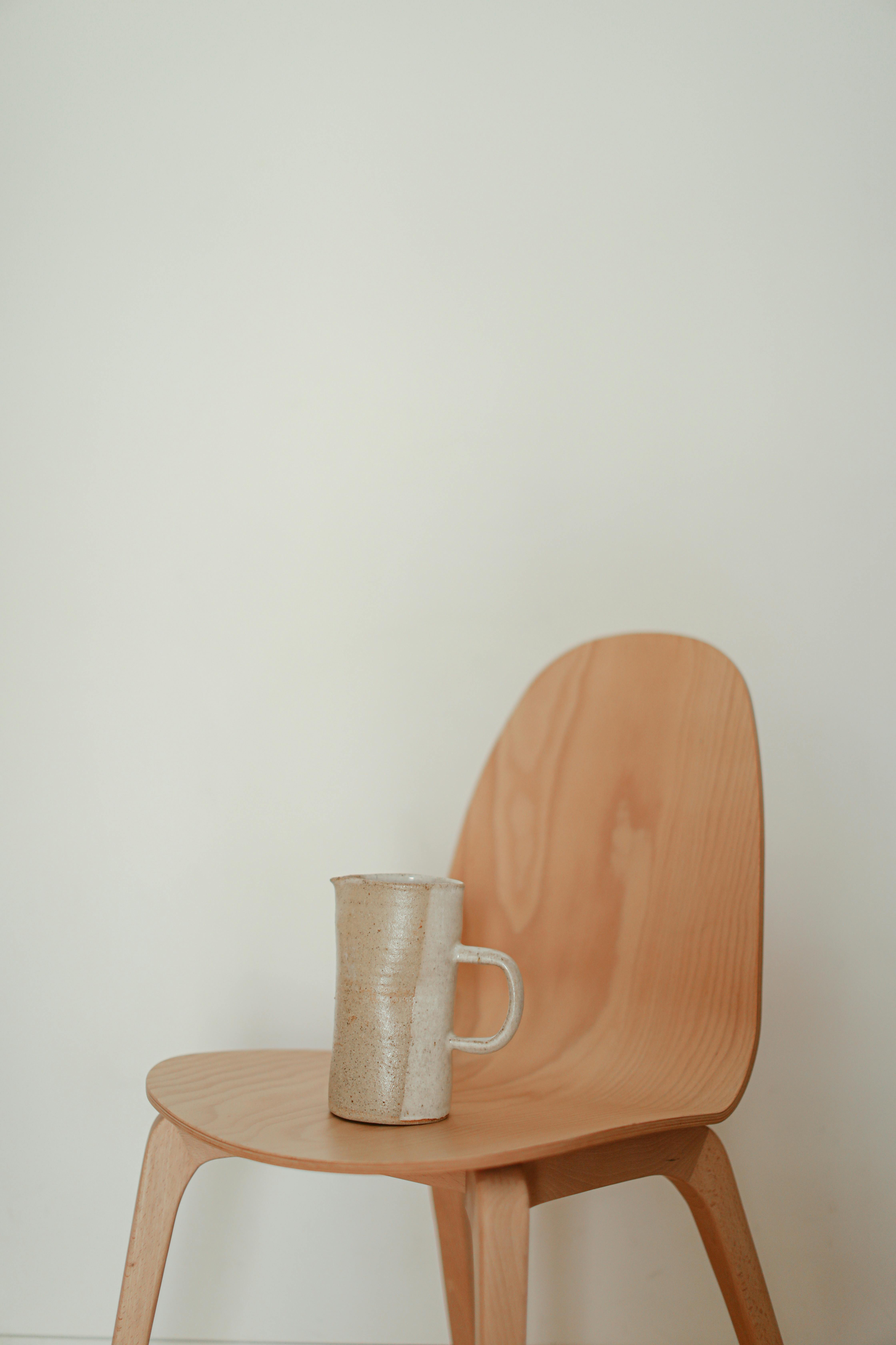 Empty Wooden Chair Near White Wall · Free Stock Photo