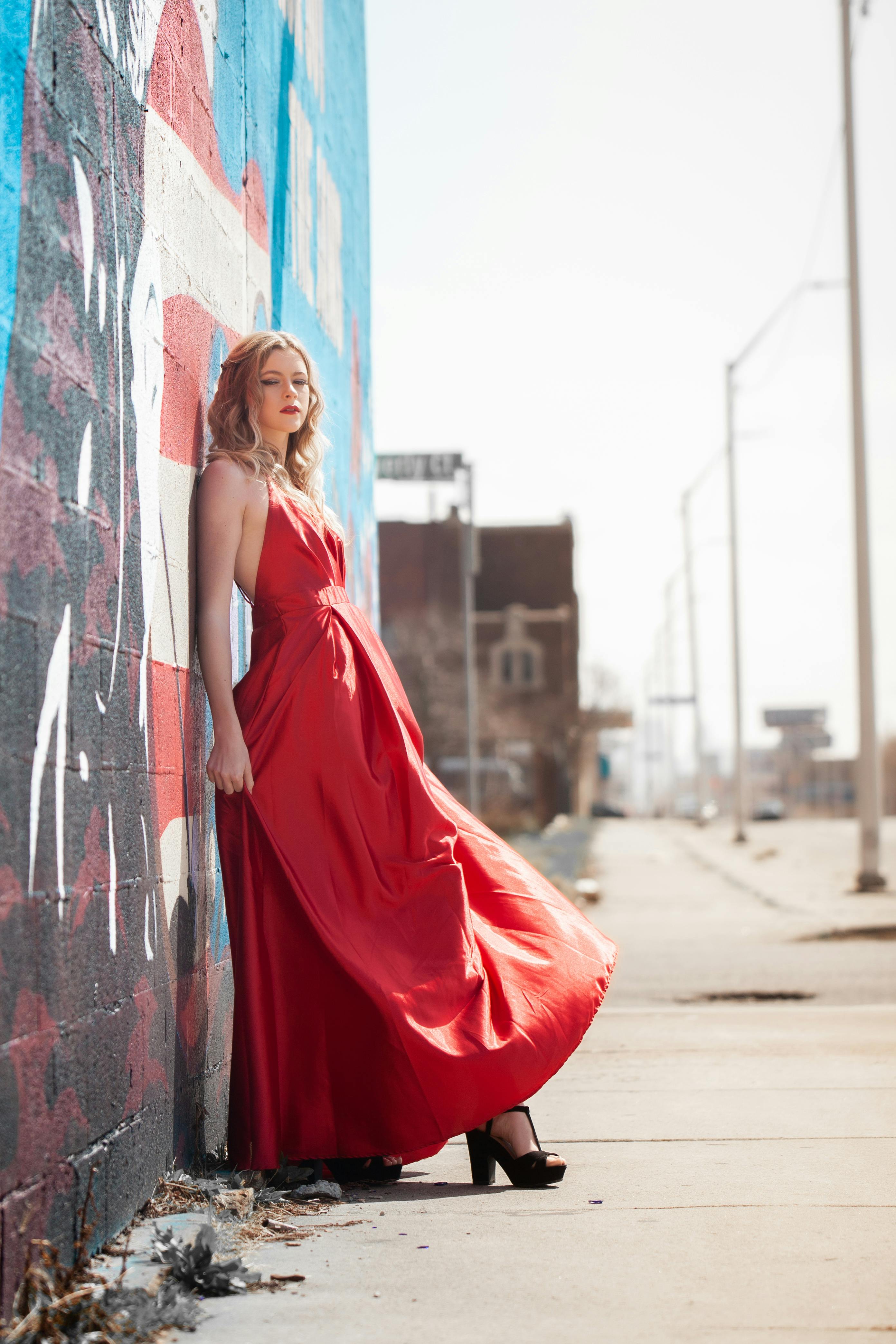 Woman in Red Gown Near Wall · Free Stock Photo