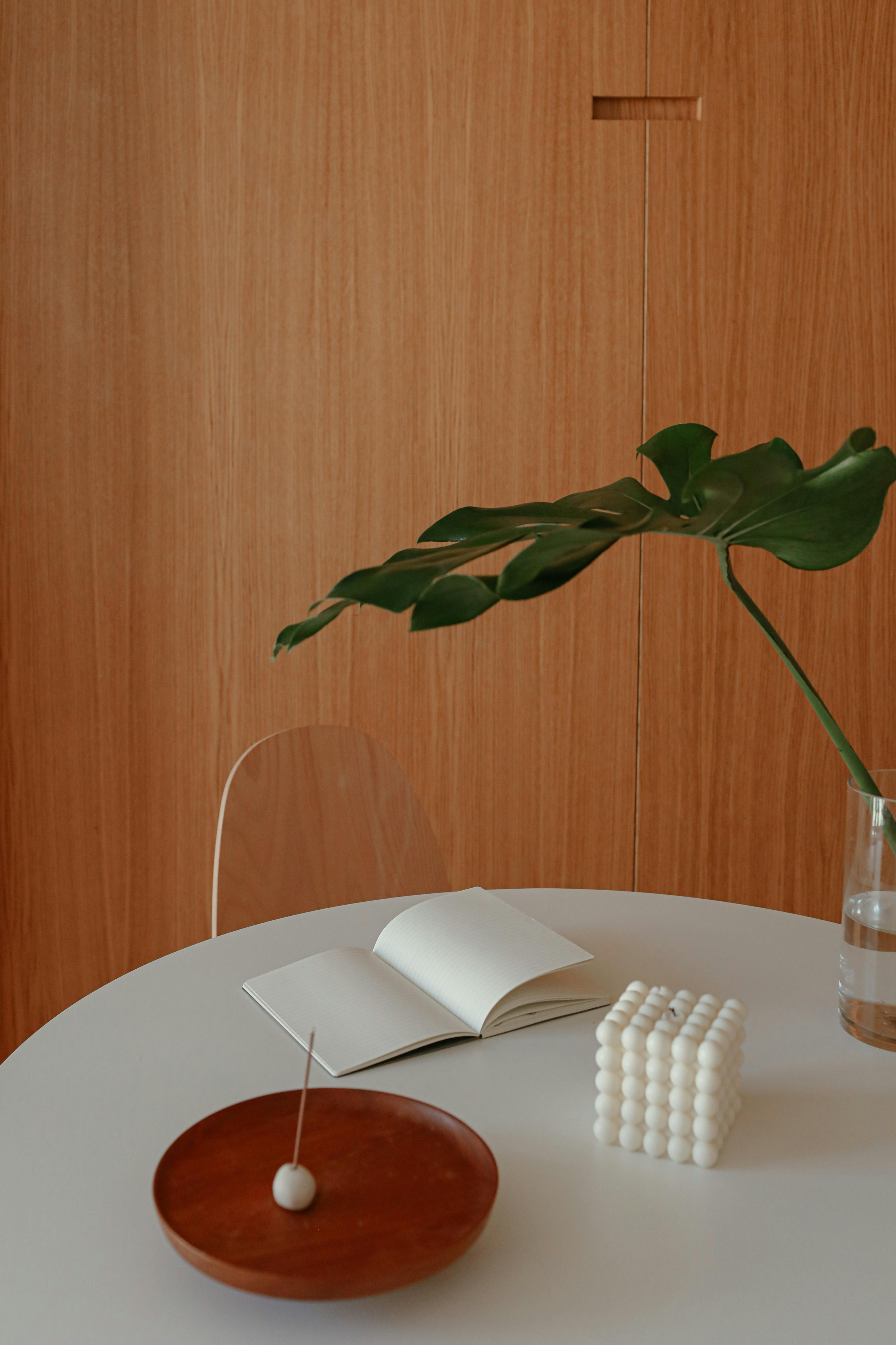 White Notebook on White Round Table · Free Stock Photo